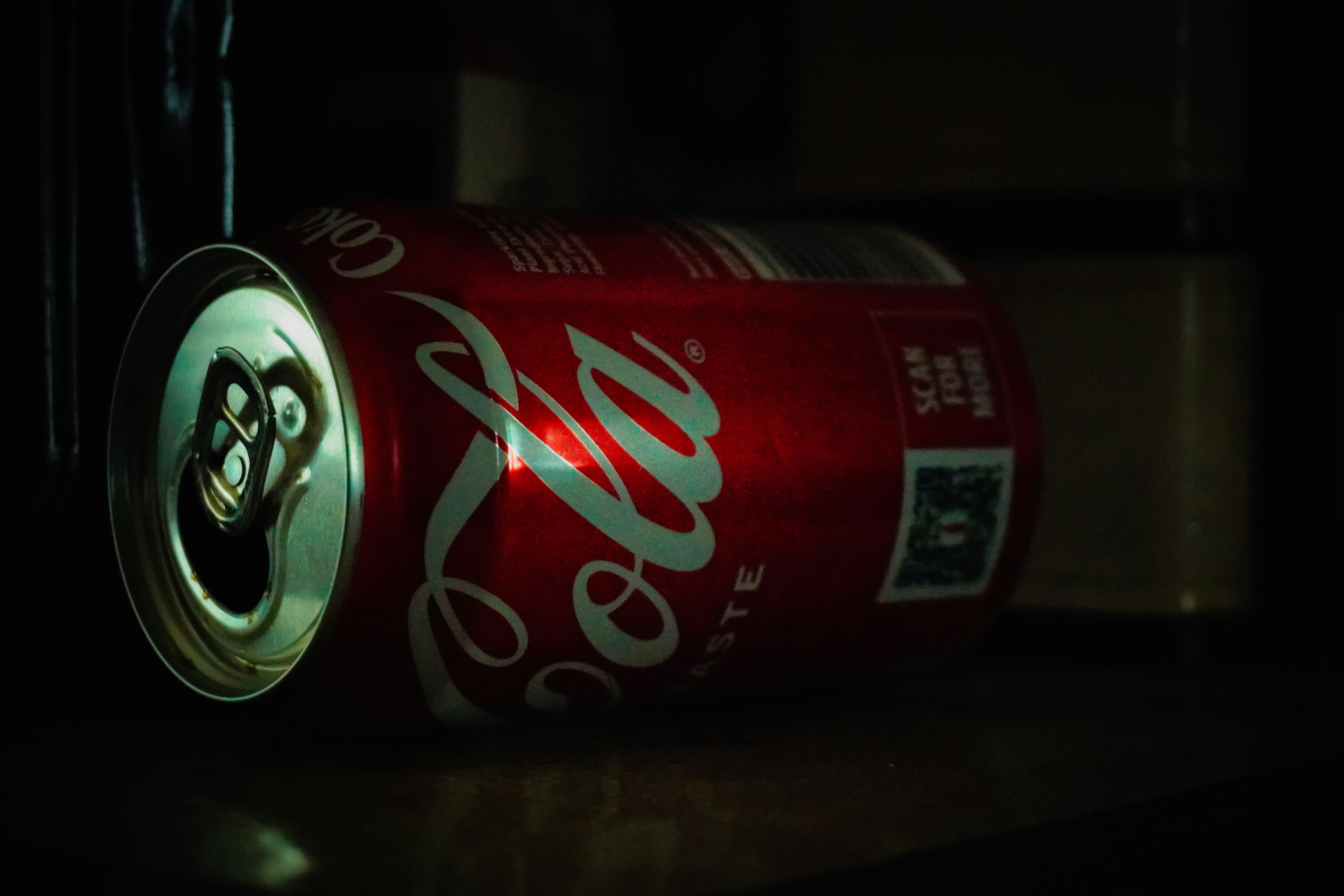 Dim Glow: Coca-Cola Can in a Quiet Corner