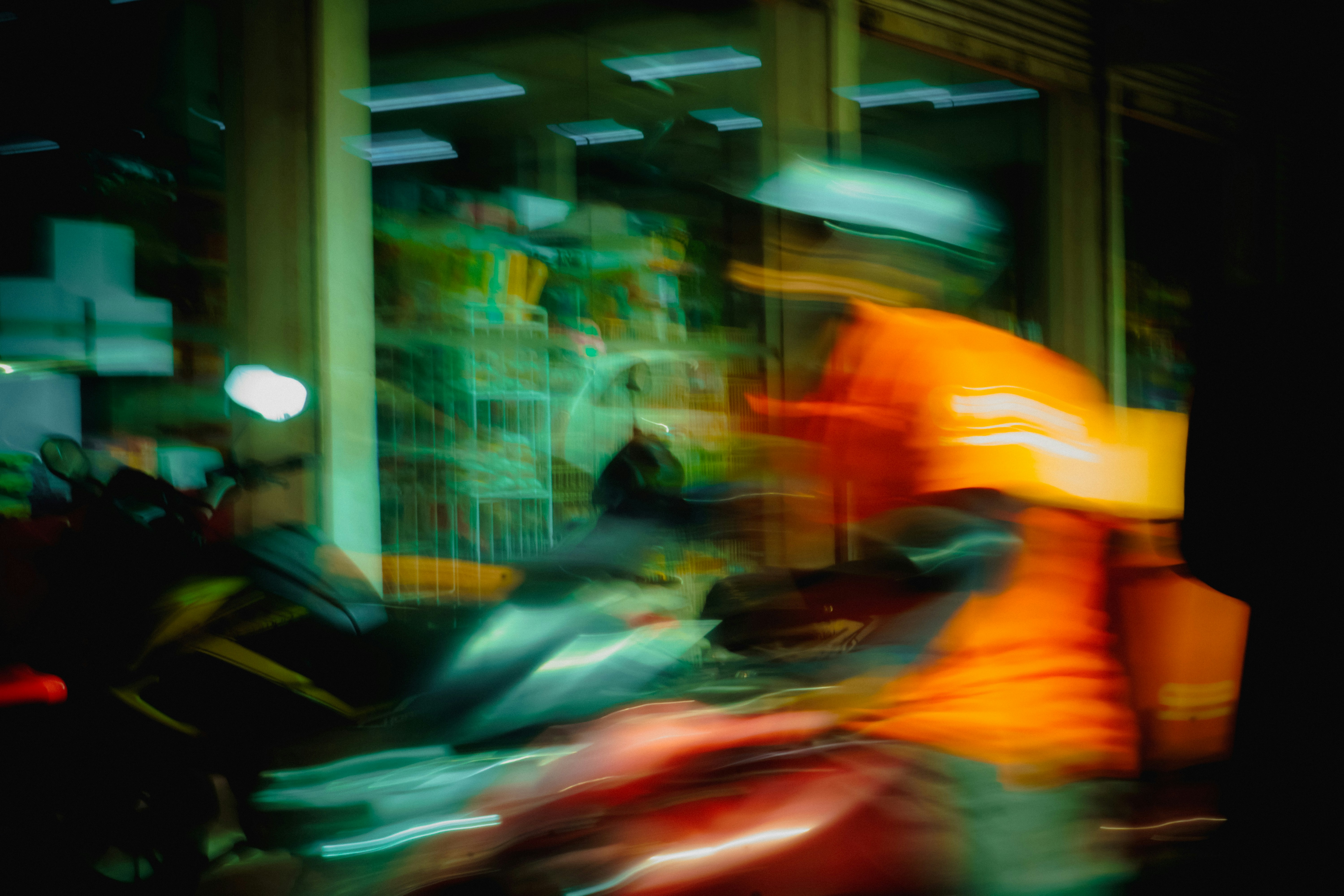 Motion in Neon: A Blurred Rush Through a City Shopfront