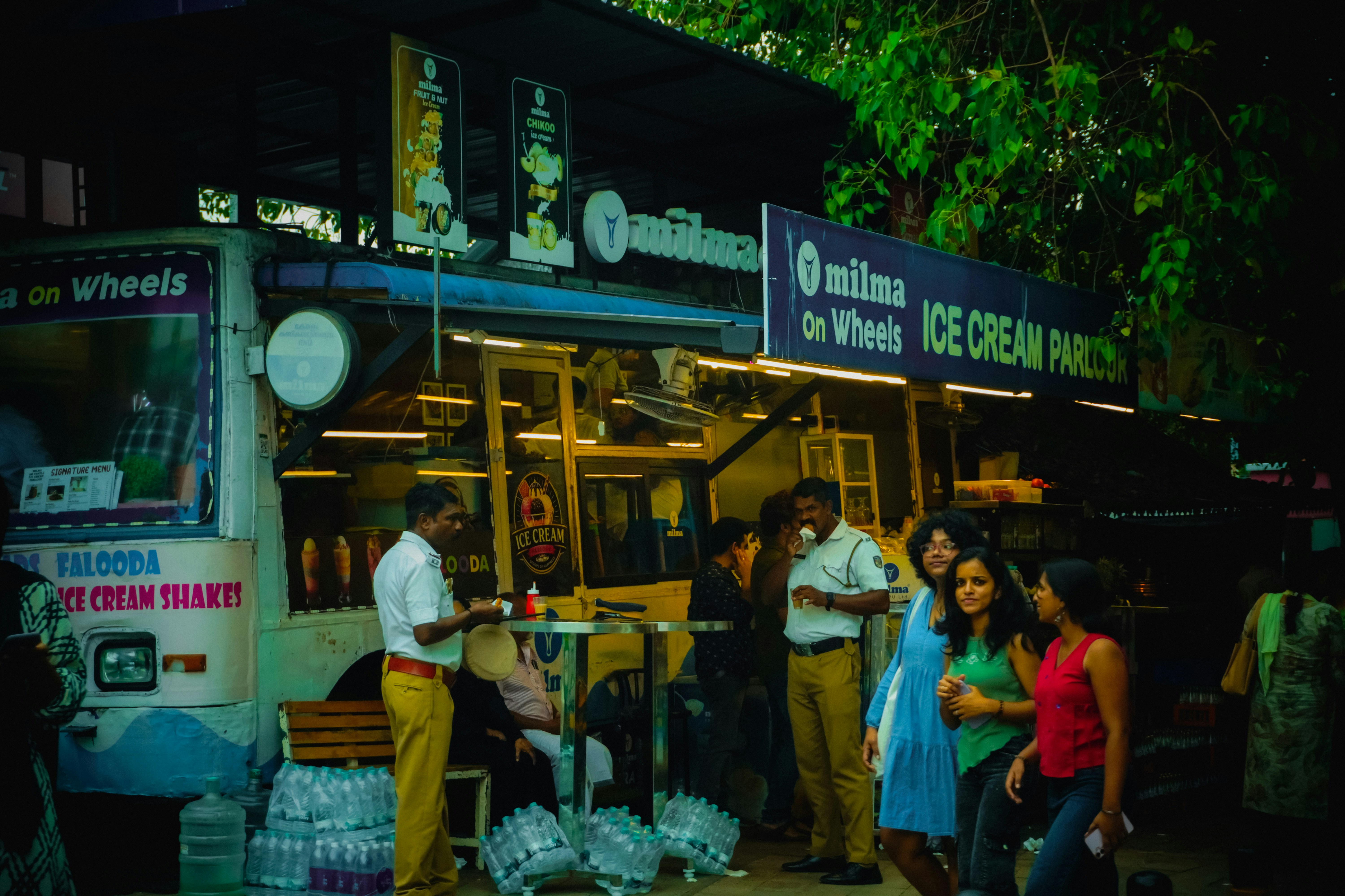 Ice Cream Stop Under Neon Signs: a Busy Street Moment