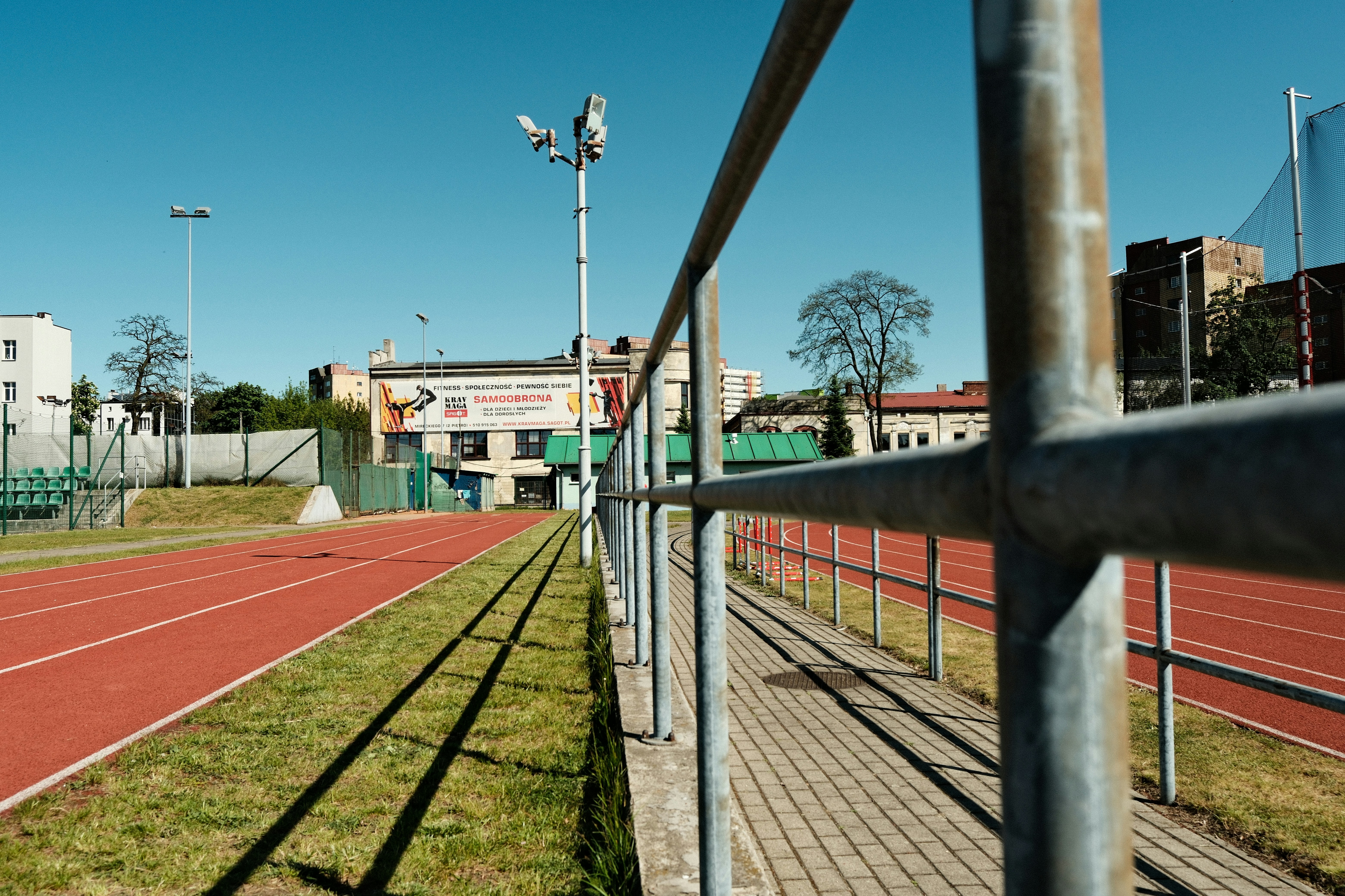 Stadium Track Viewed Through Metal Railing