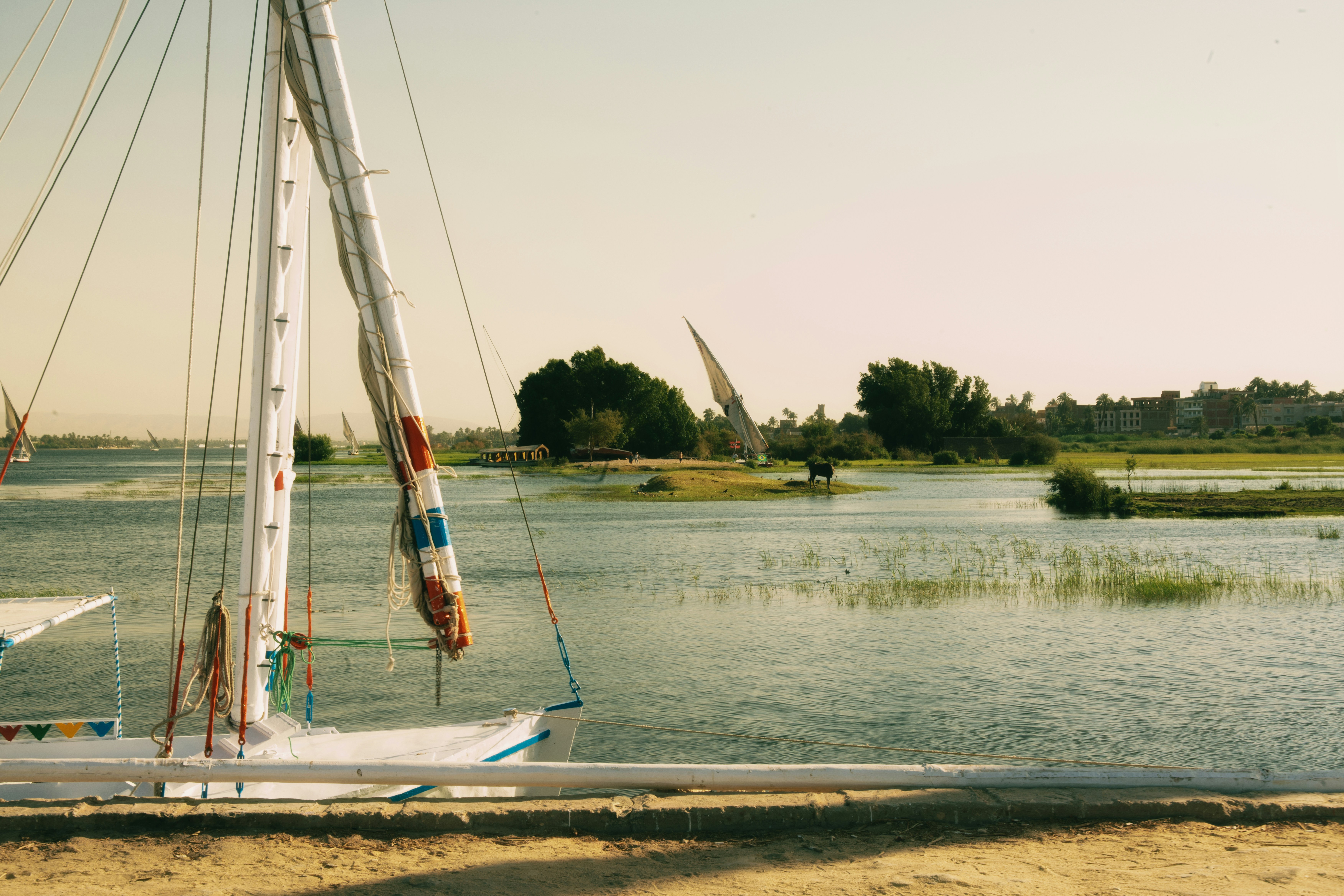 Sailboat at the Edge: Quiet Tide by the Sand