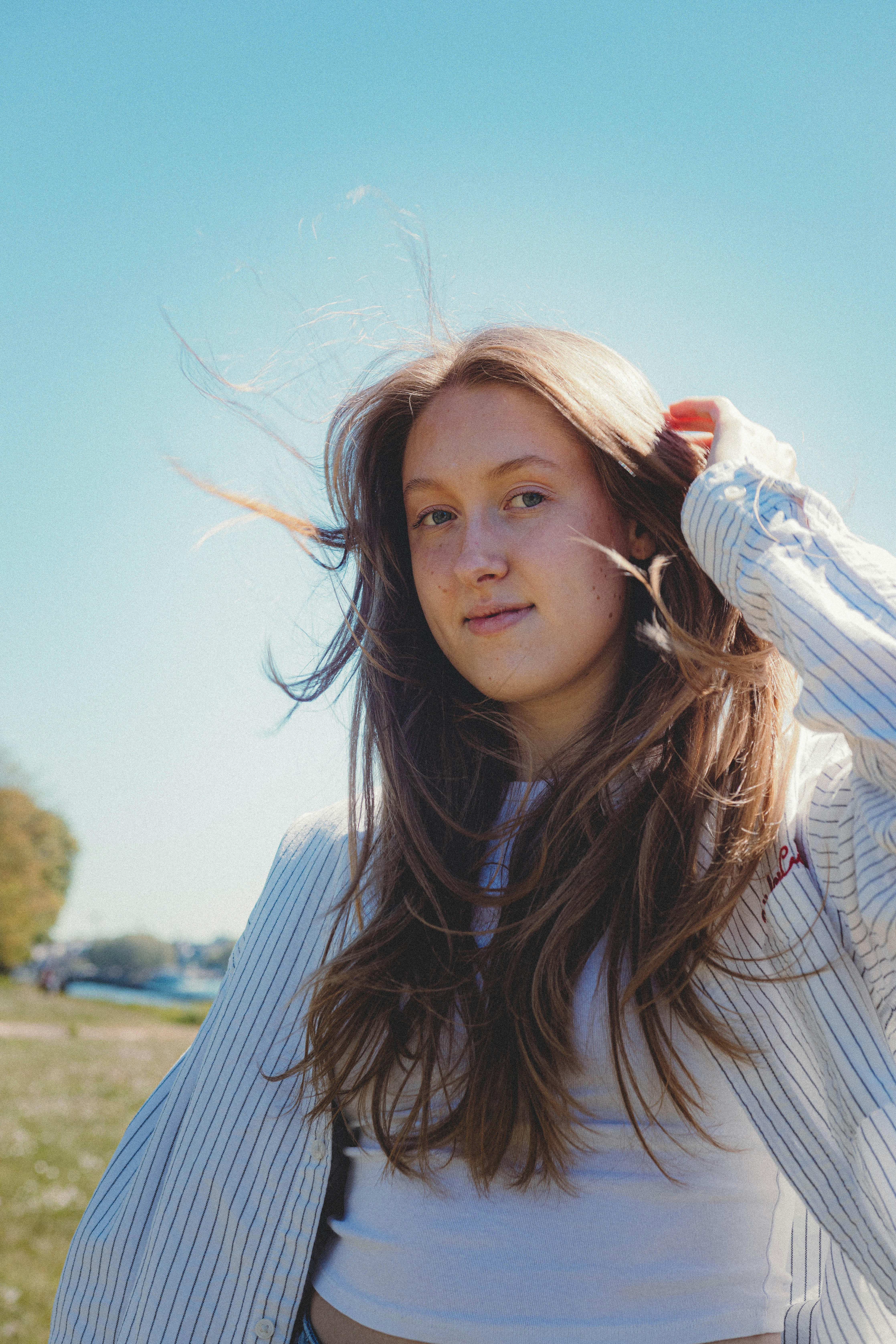 Young woman with long hair blowing in the wind.