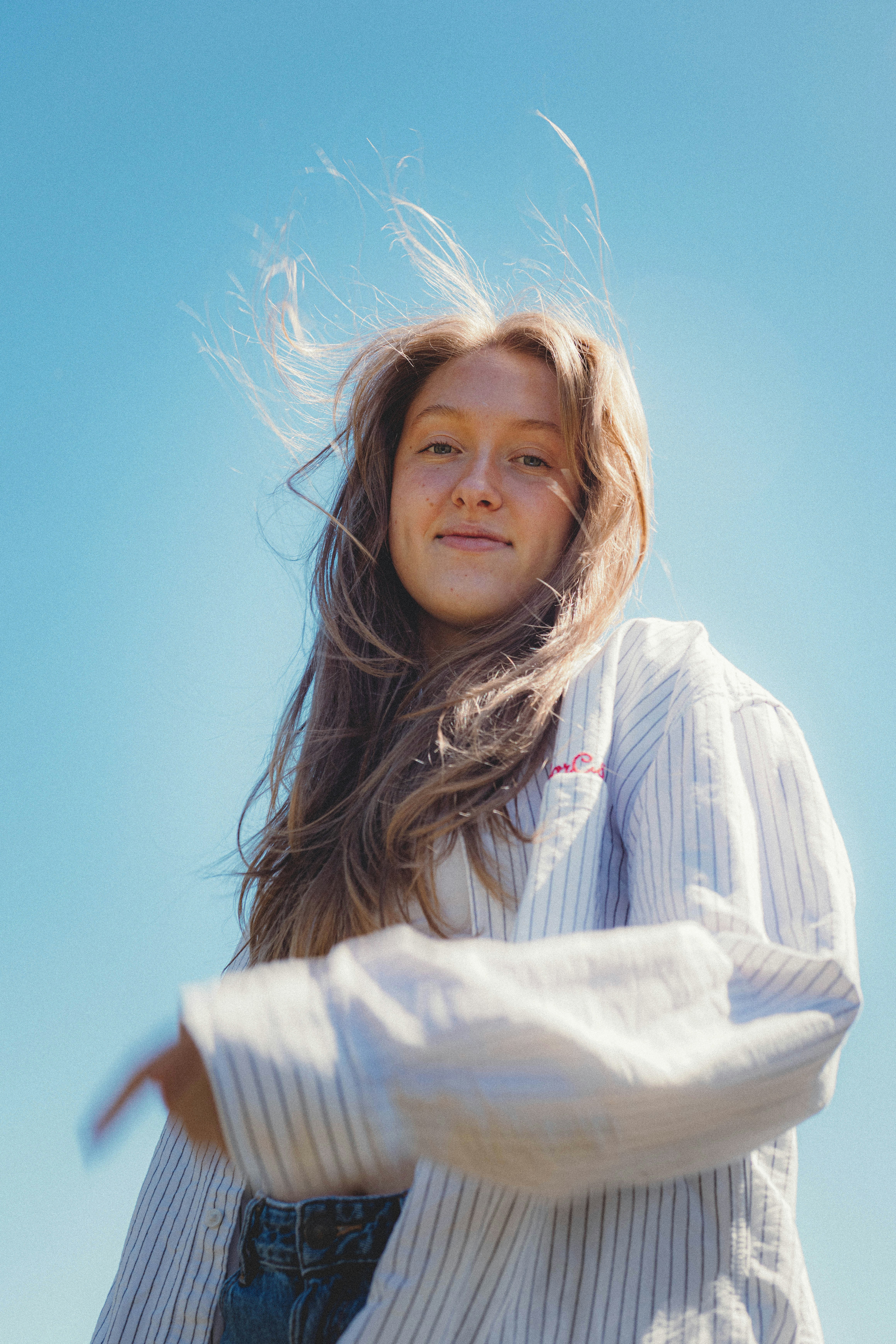 Portrait in the Sky: A Sunlit Portrait with Wind-swept Hair