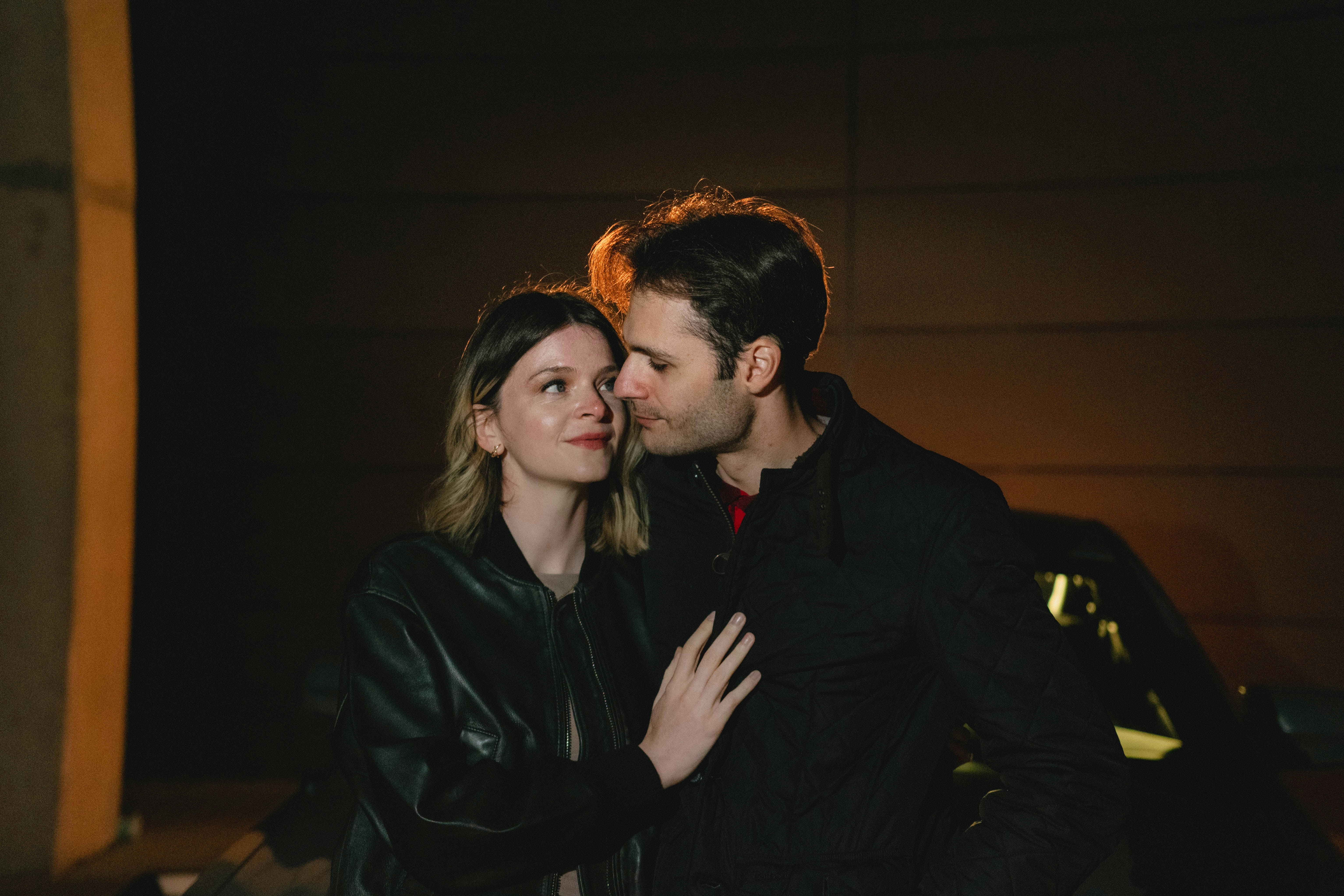 Affectionate couple embracing outdoors in the evening.
