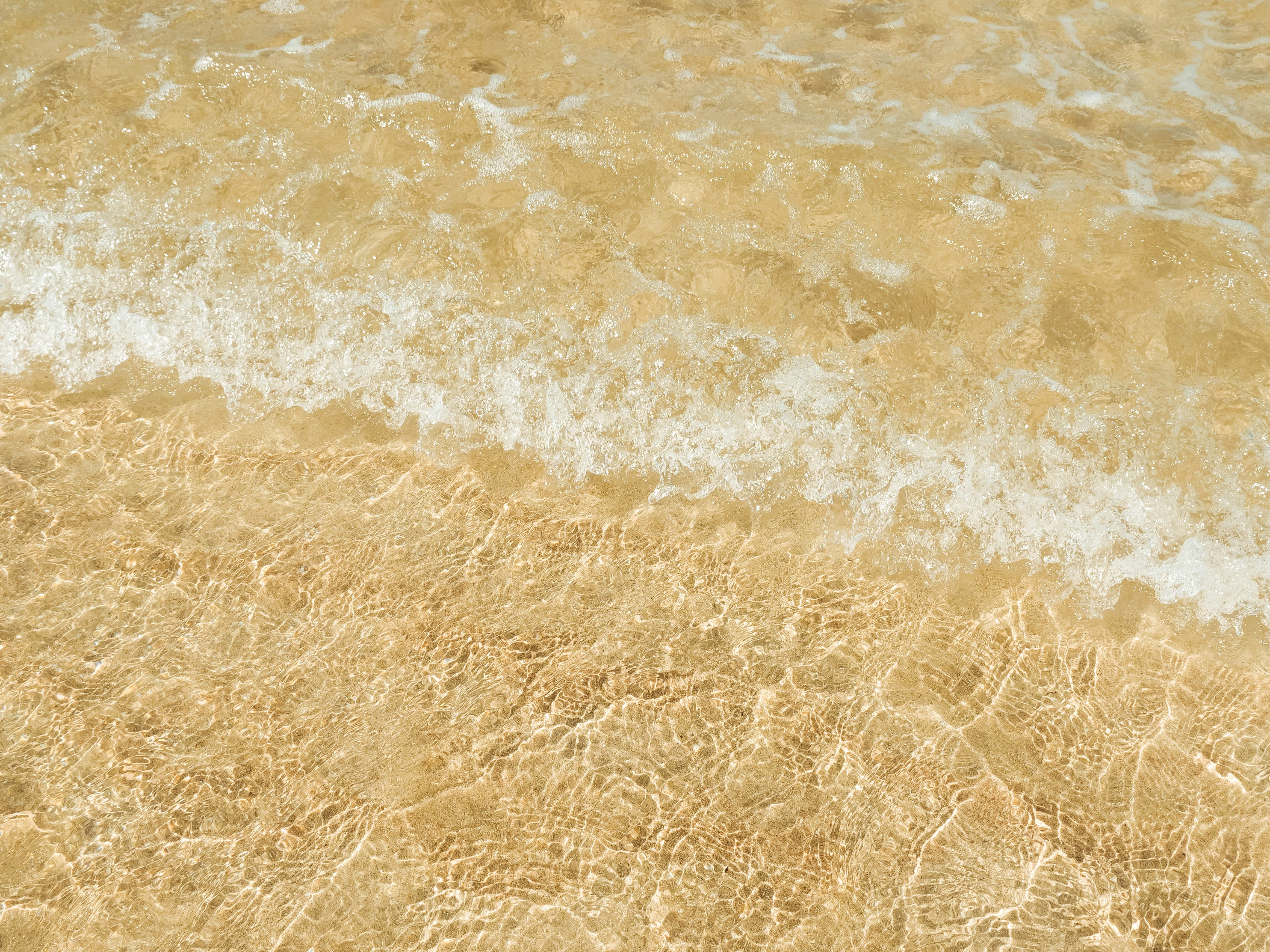 Golden Shoreline Ripple: Amber Sea under Quiet Light