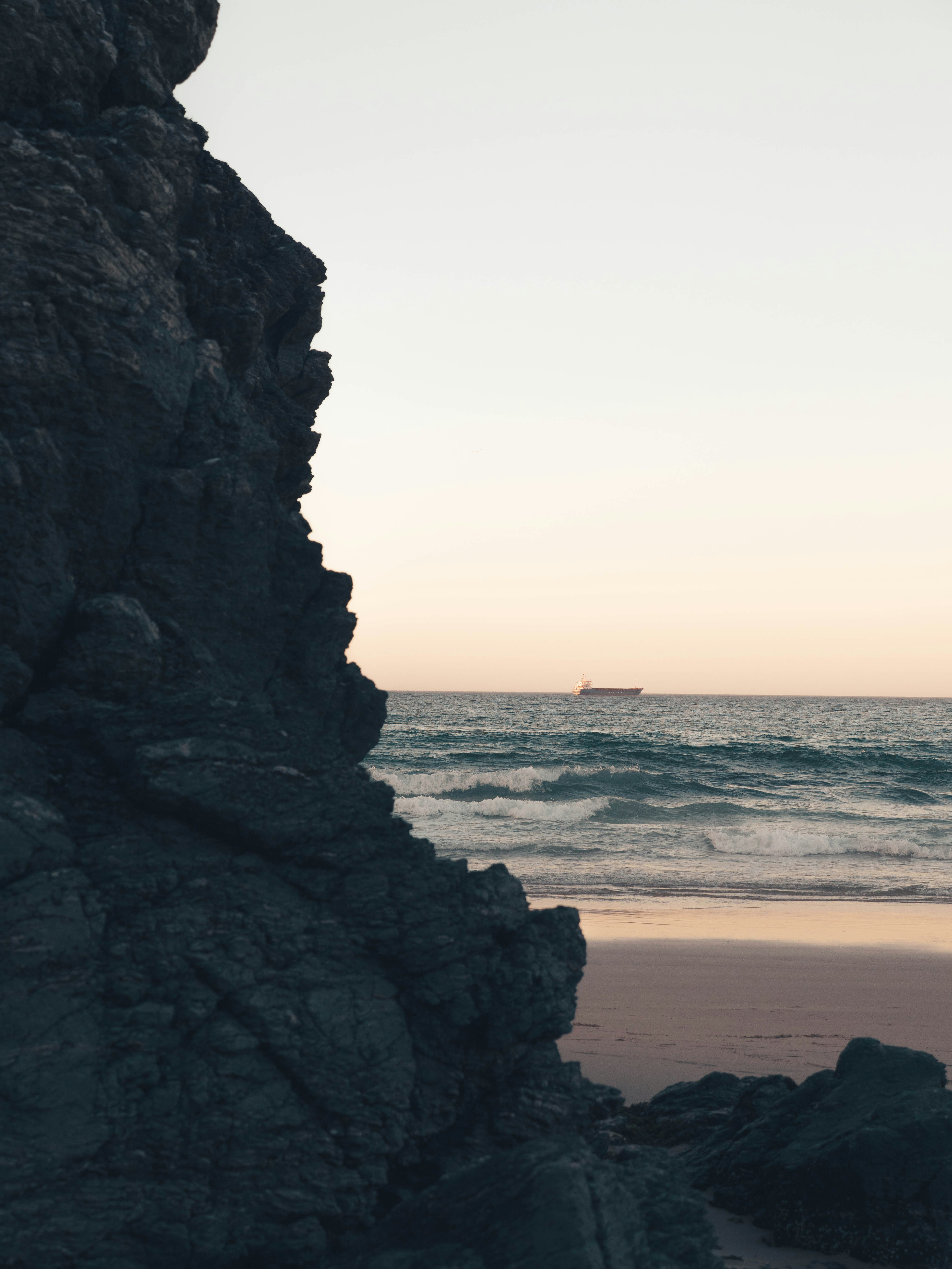 Sunlit Sea Beyond the Cliff Face