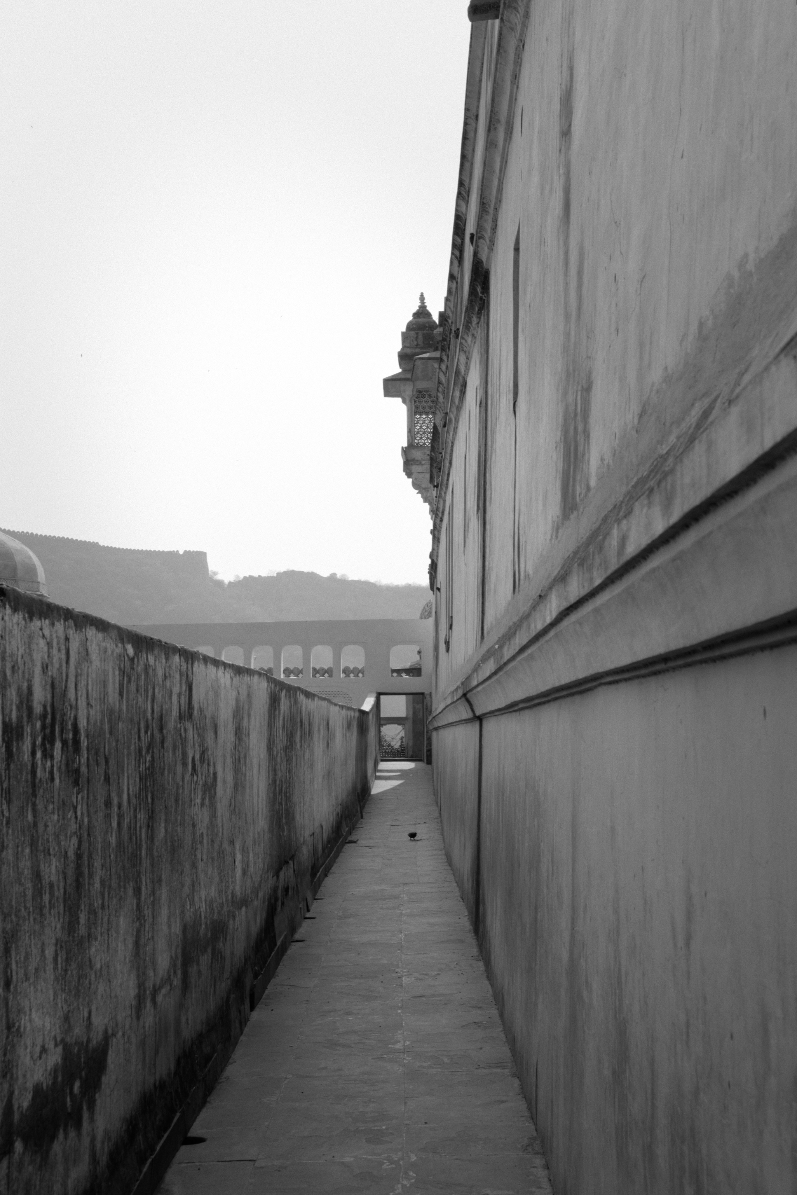 A Narrow Corridor Toward the Light at the Far Arch