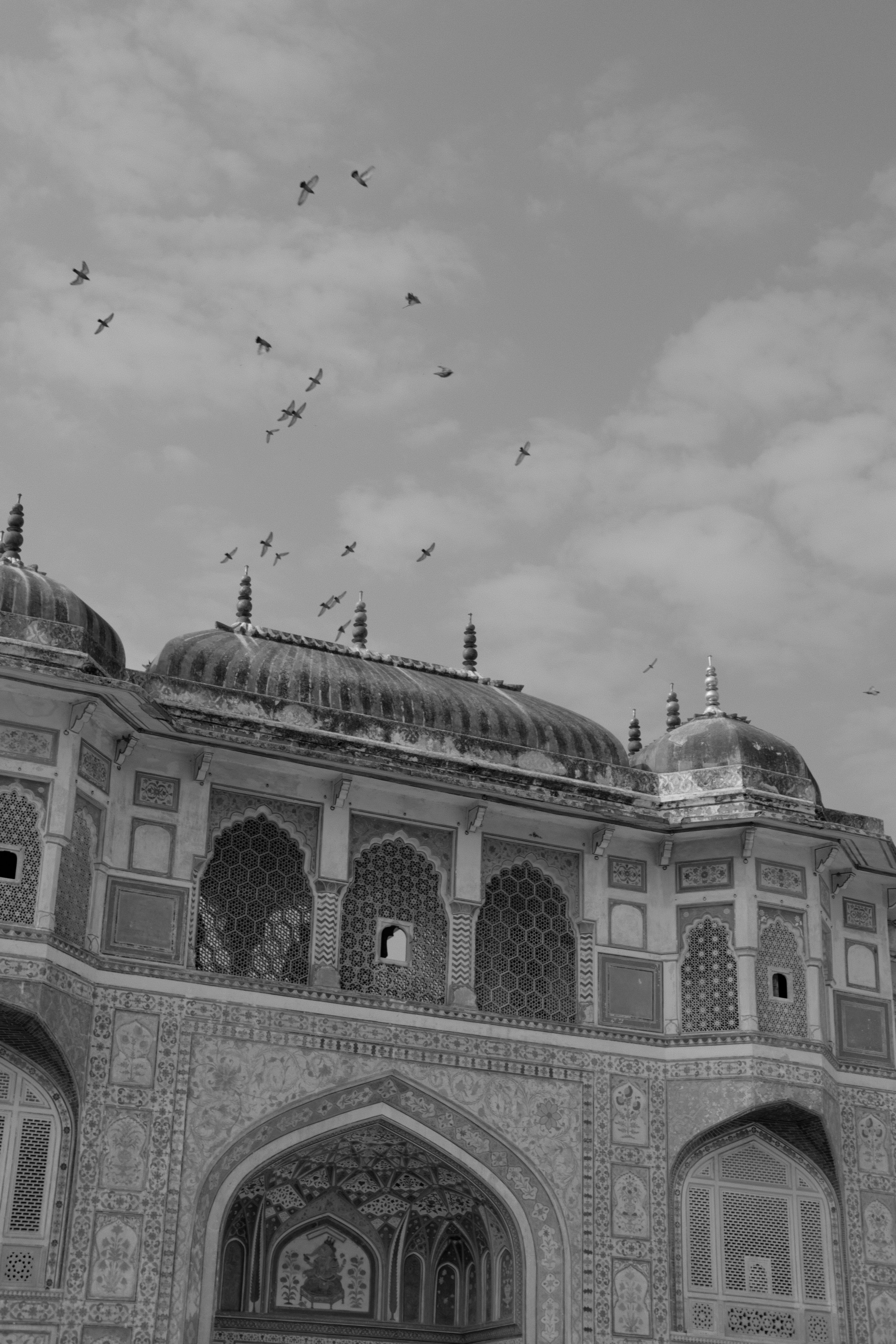 Granite Carved Facade under a Sky of Doves