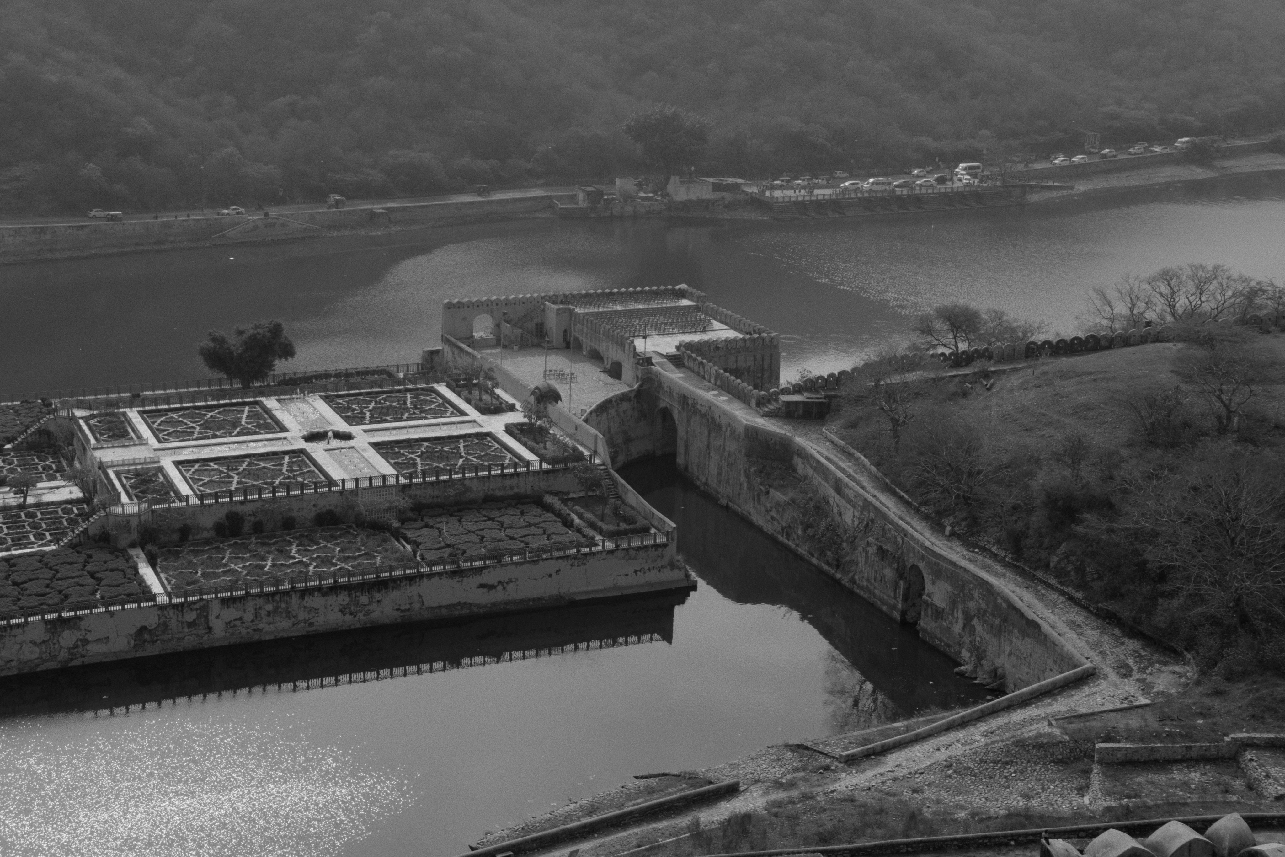 Historic garden island and causeway in a vast lake.