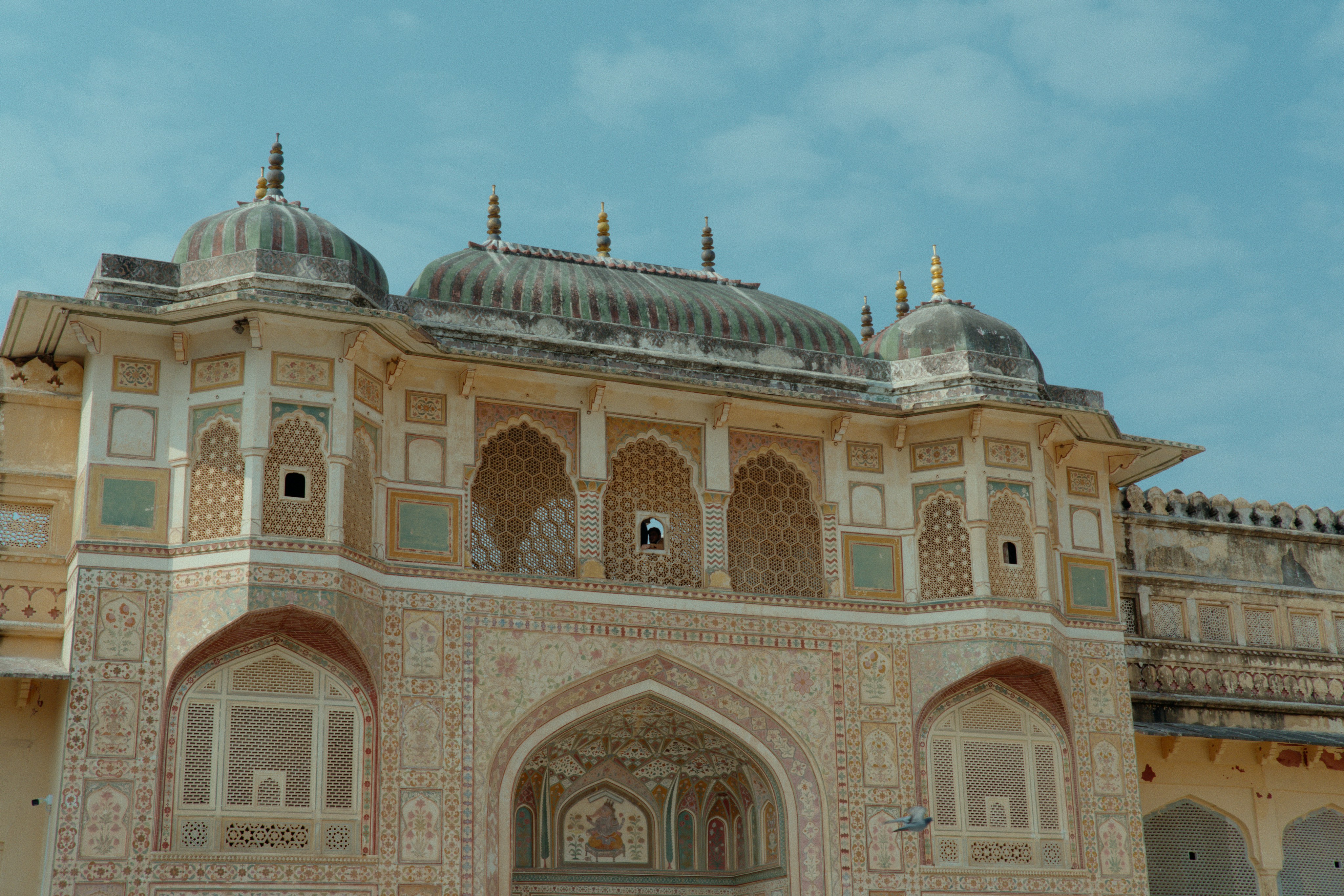 Ornate historic indian palace with domes and intricate architectural details.