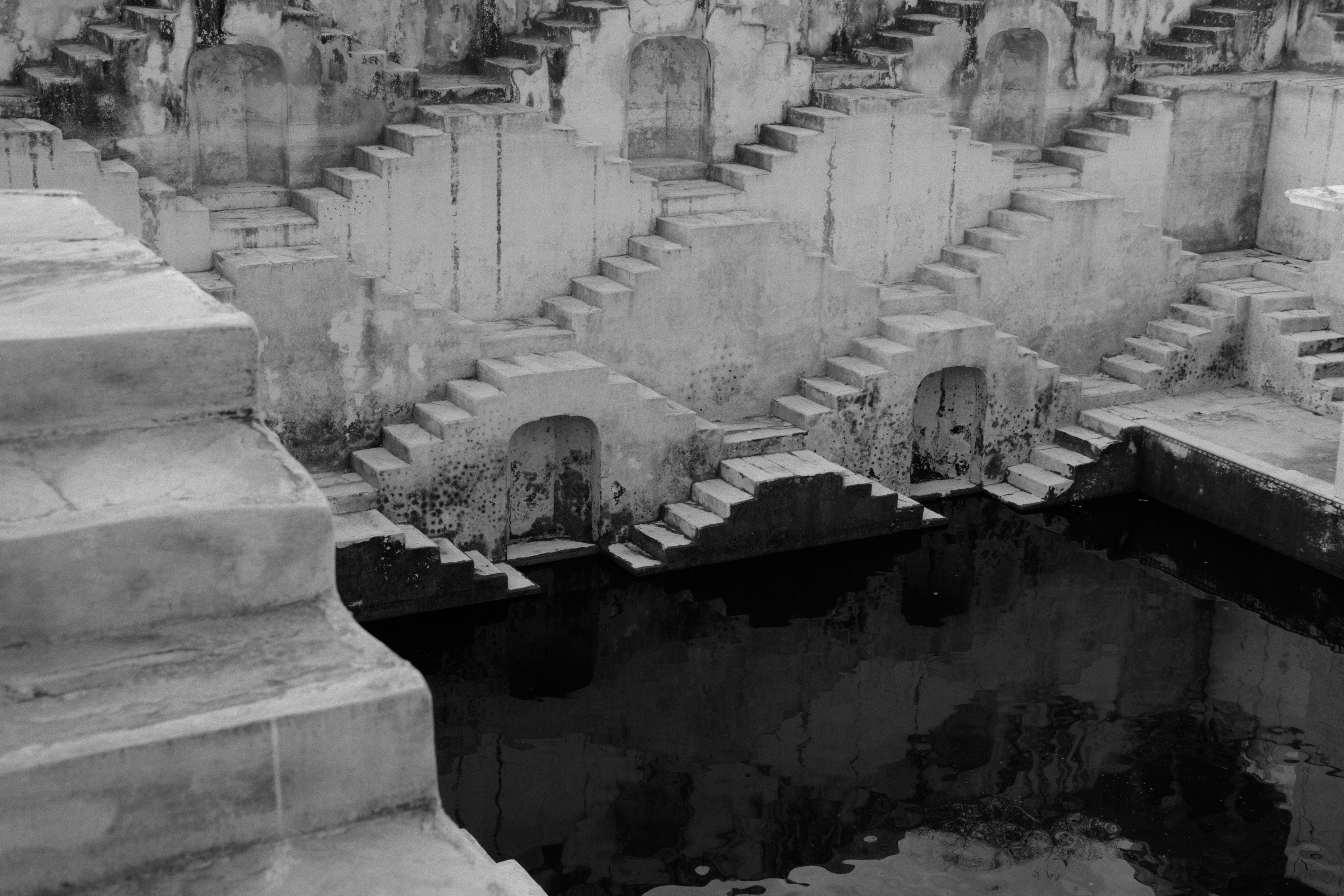Terraced Tombs over Quiet Water: A Monochrome Staircase Field