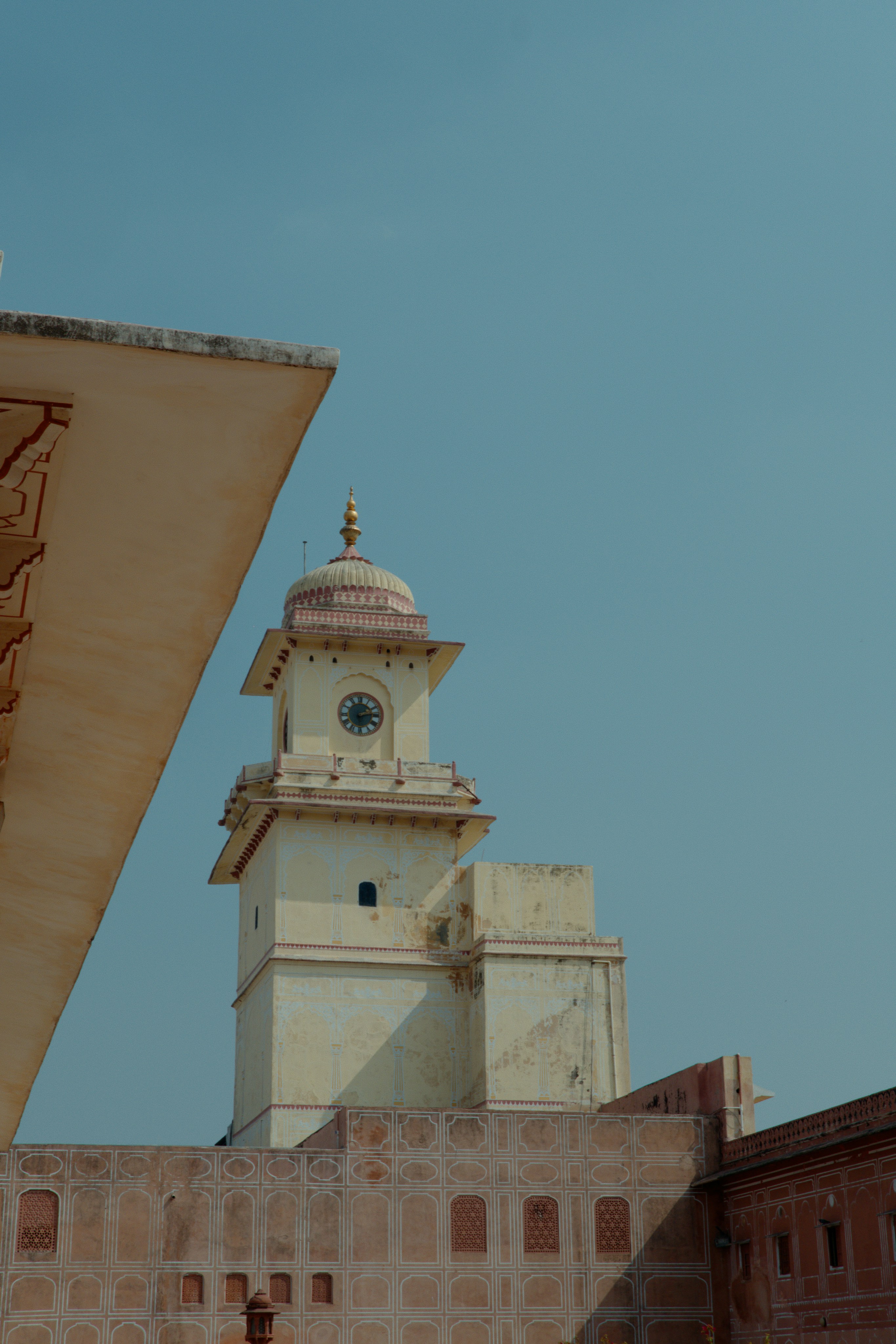 Clocktower Of The Courtyard: A Quiet Corner Under Clear Sky