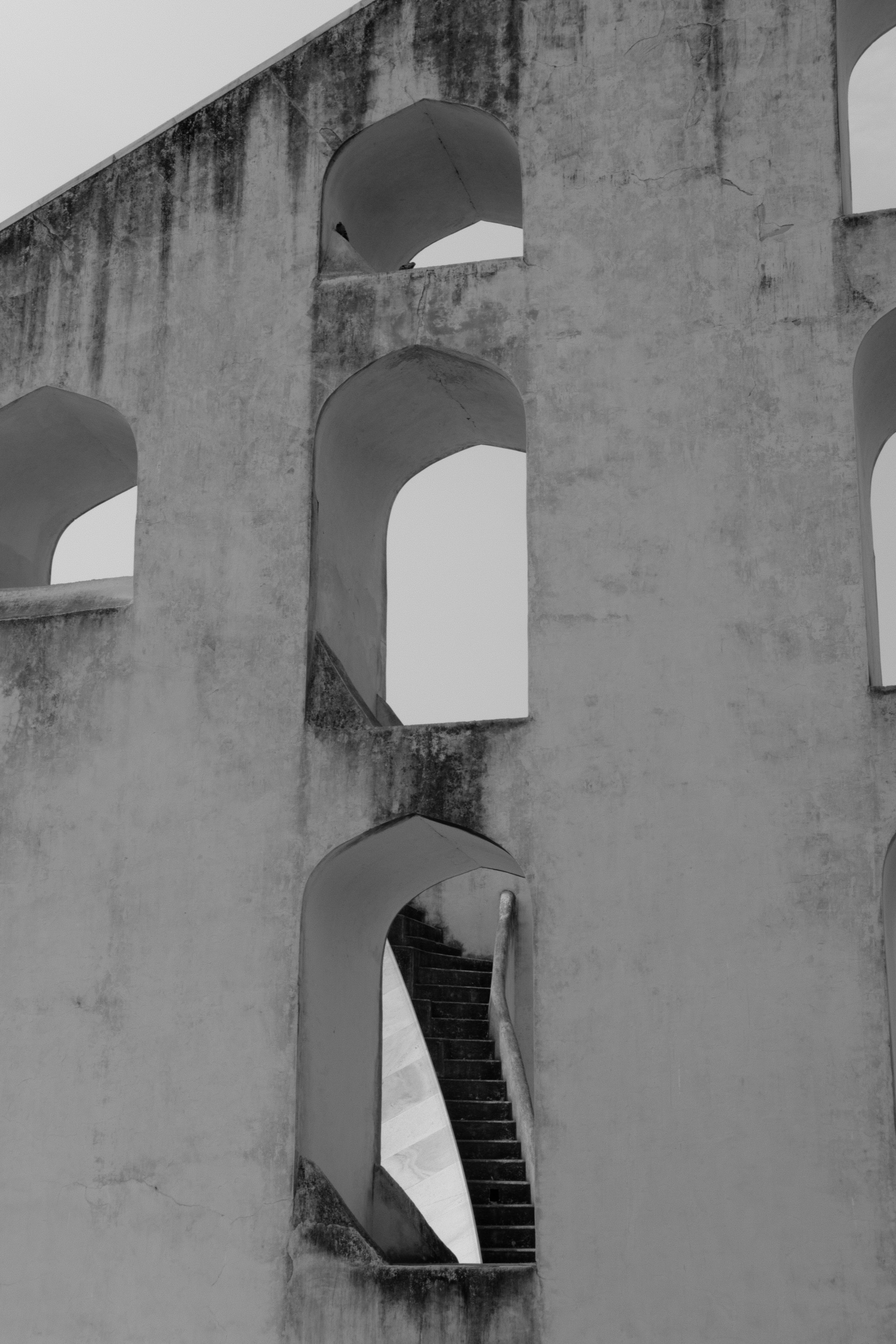 Monolithic Arches: A Stairway Through Light and Shadow