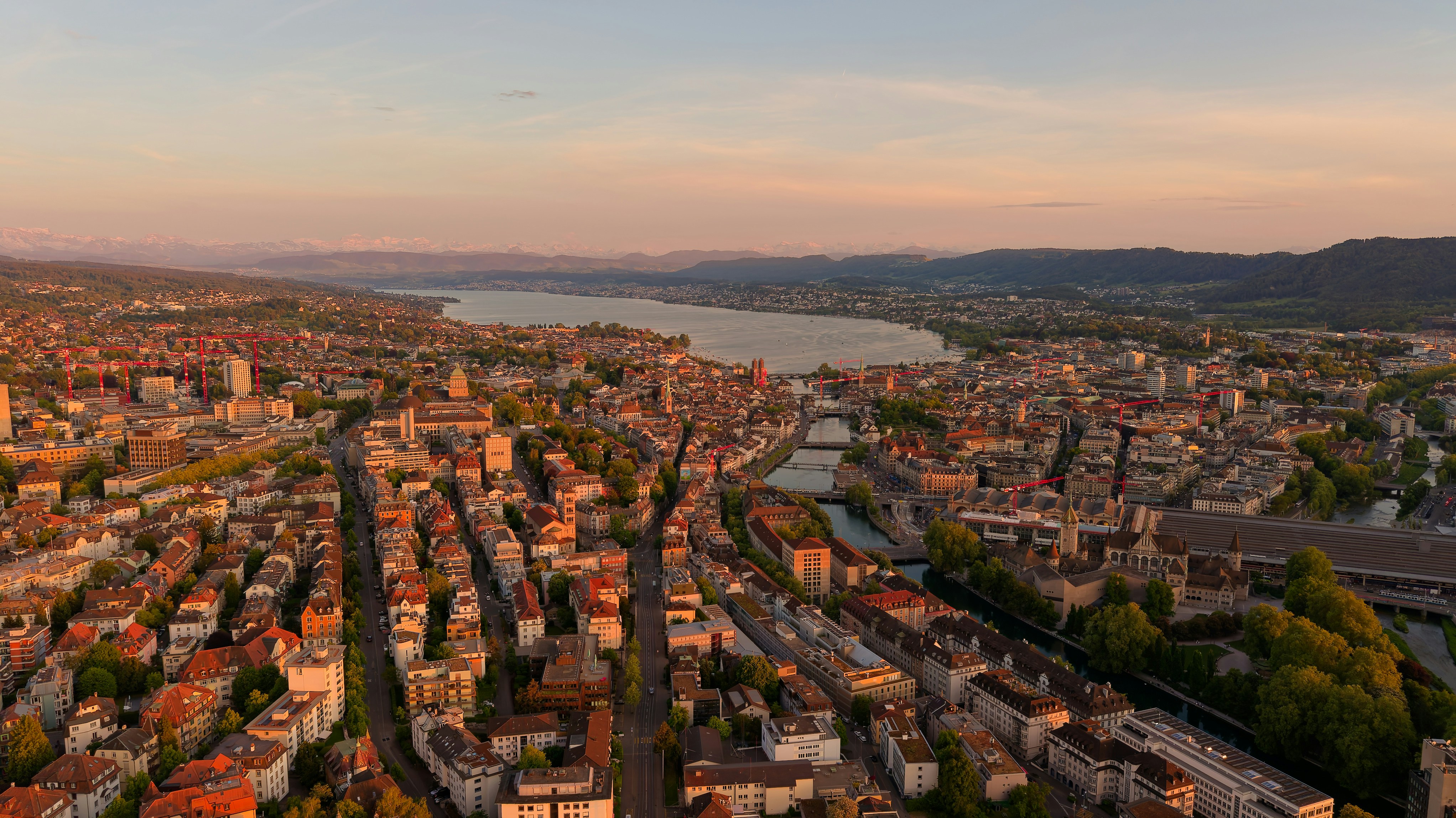 Aerial view of a city and lake at golden hour.