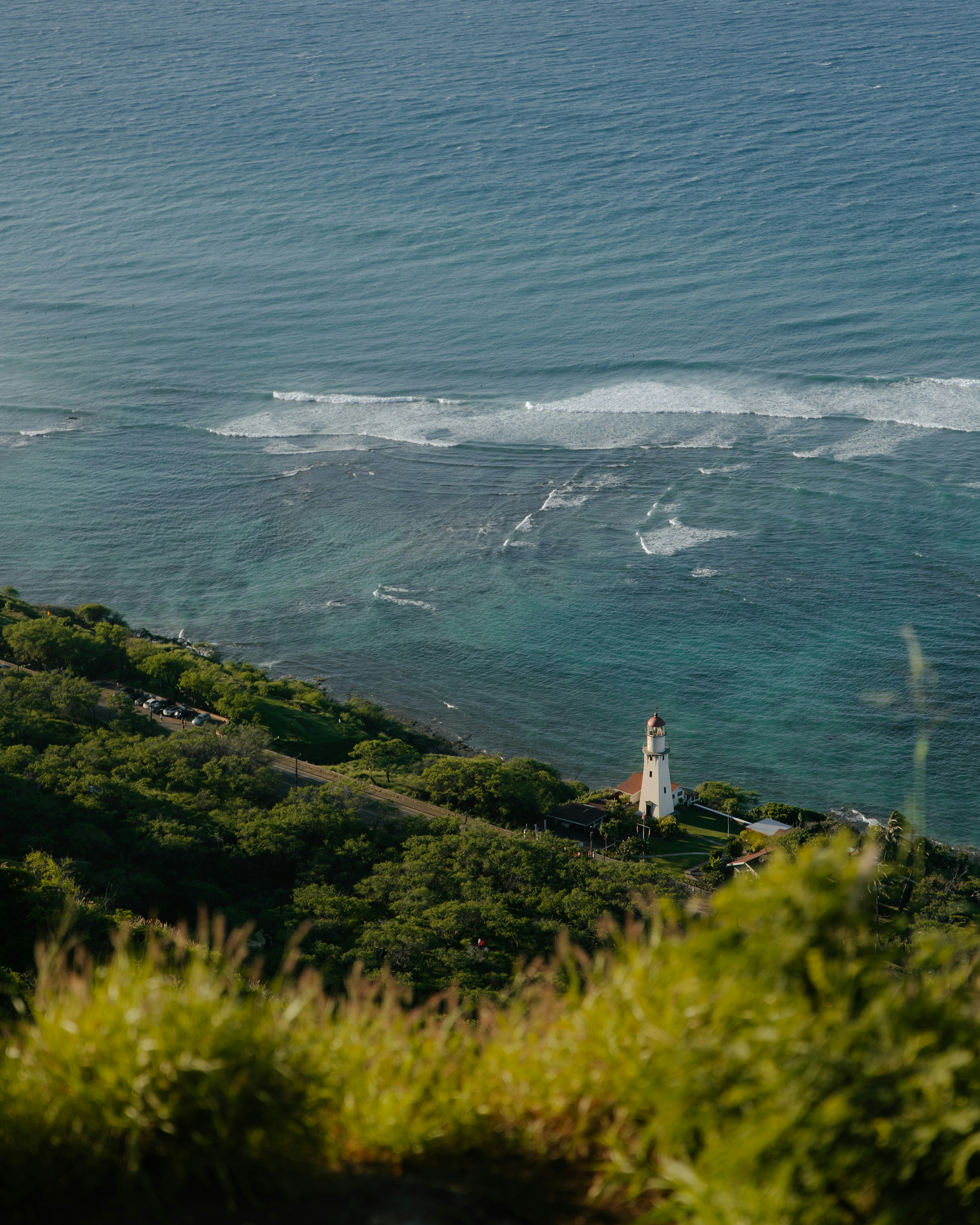Lighthouse Among Green Cliffs Over Quiet Blue Seas