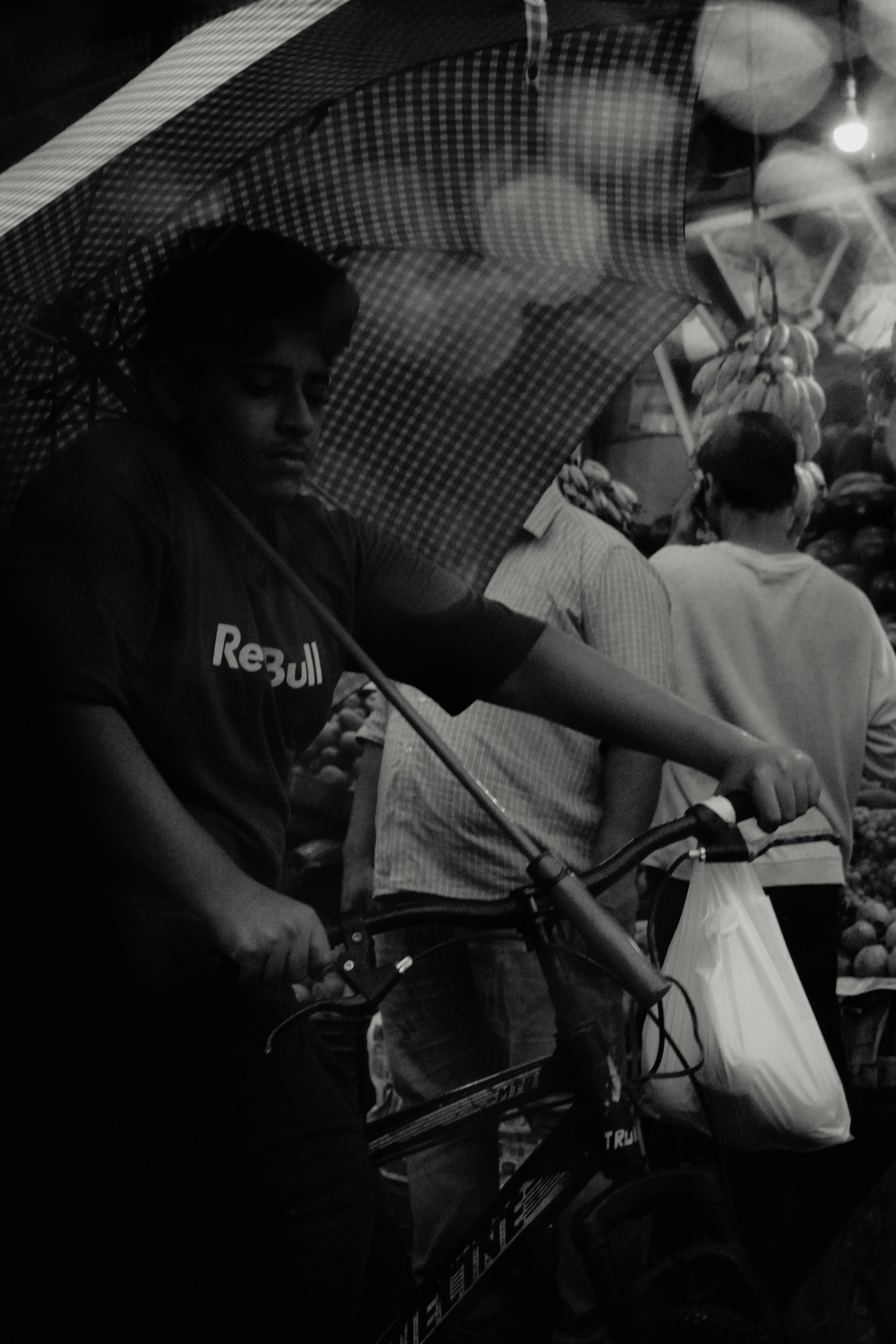 Umbrella Gaze: A Street Moment Under Dappled Lights