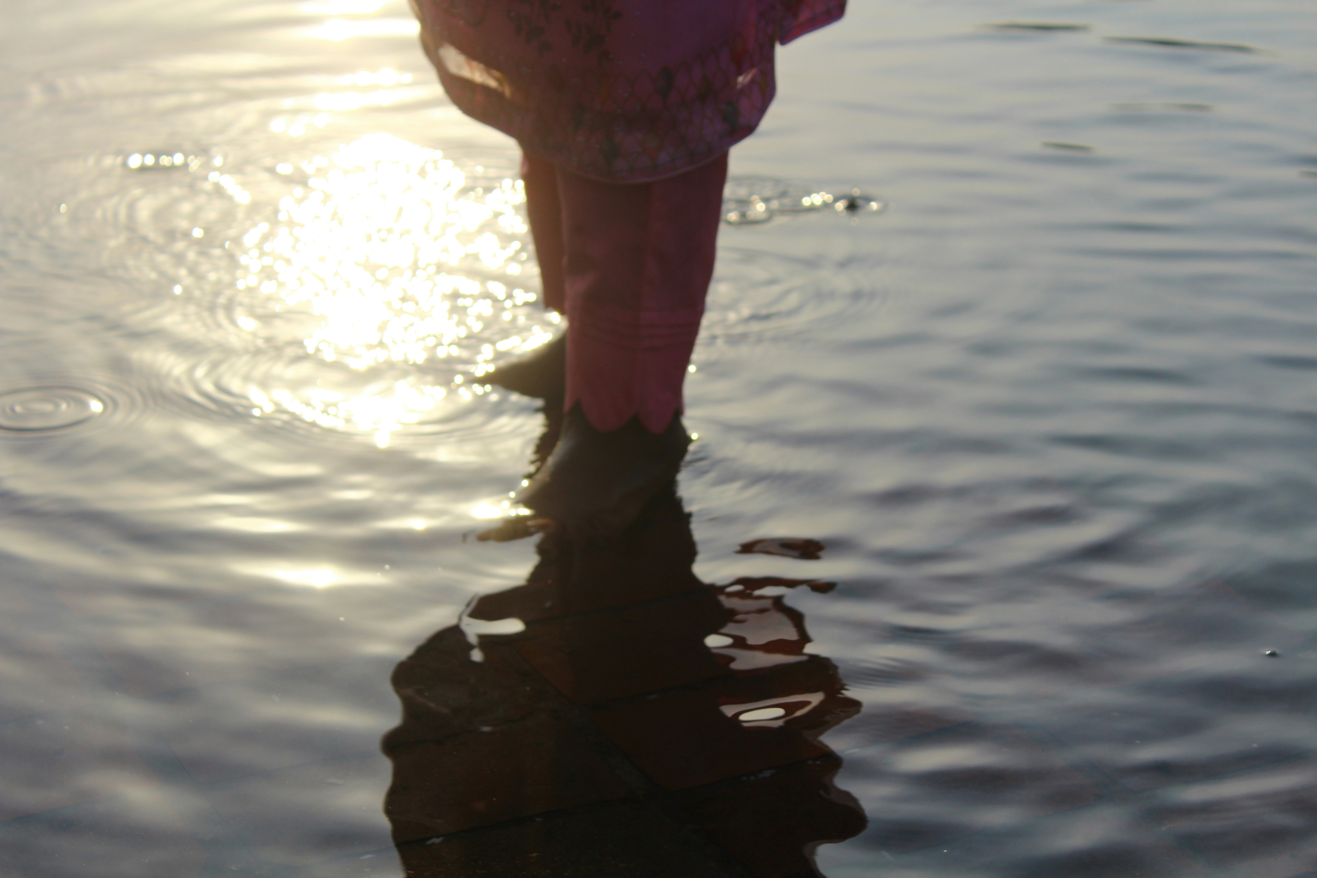 Sunlit Steps: A Figure Emerges from the Water's Edge