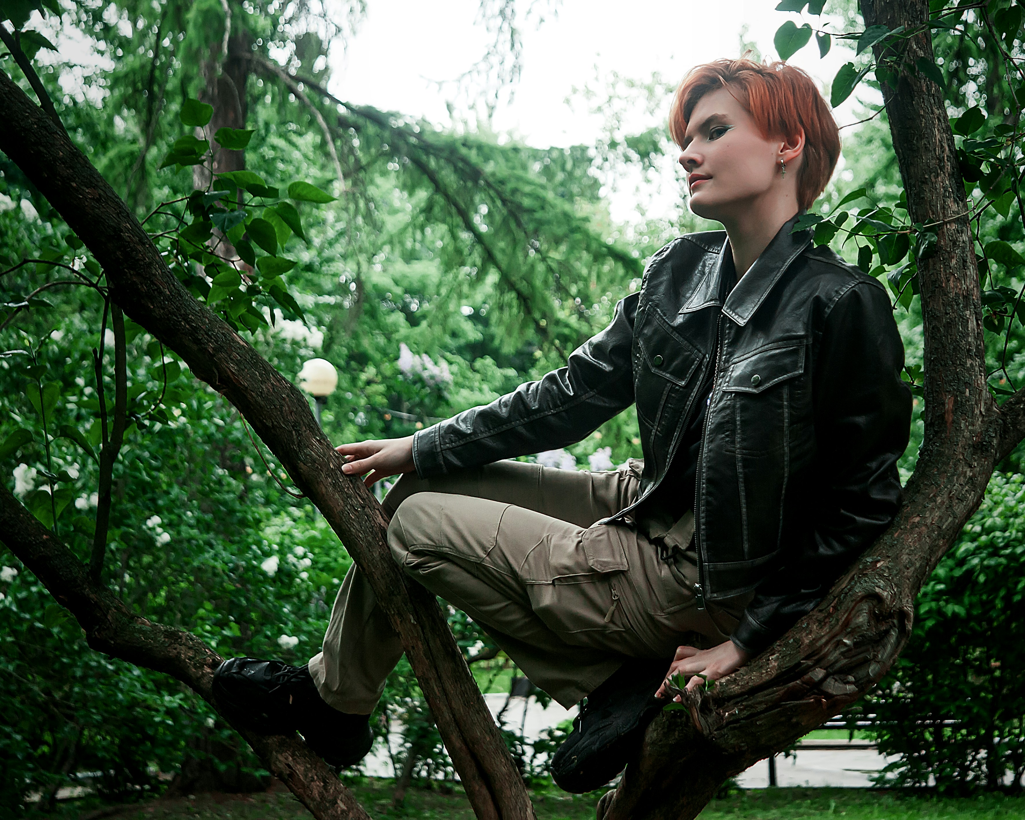 Red-haired climber among green limbs