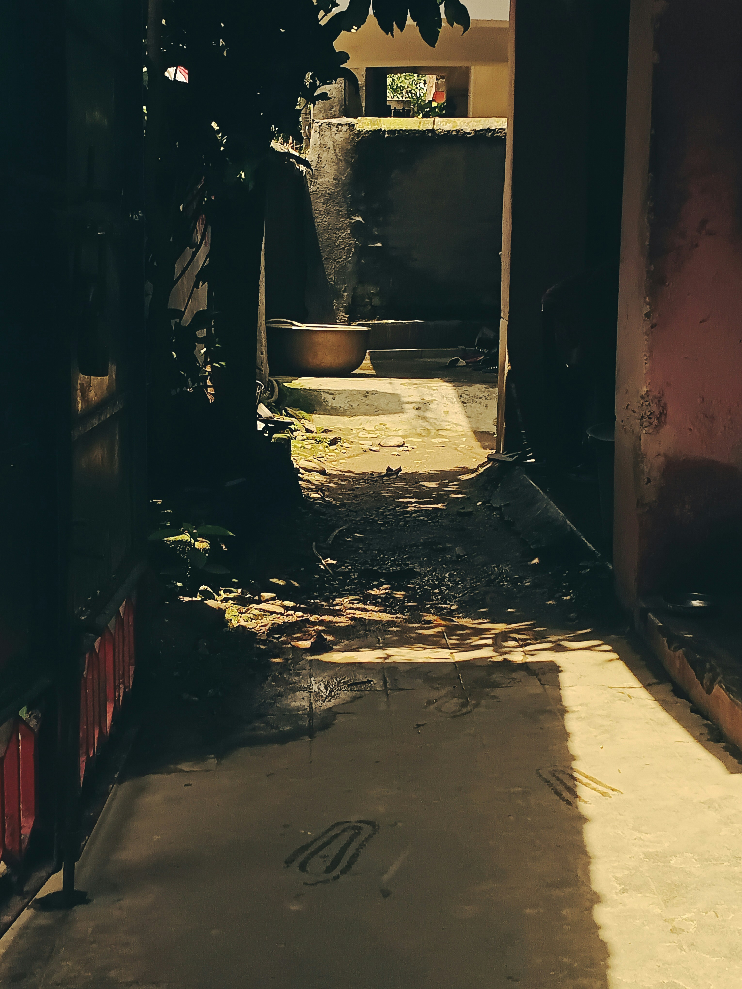 Hidden Courtyard Dawn: Narrow Alley Leading to a Sunlit Basin