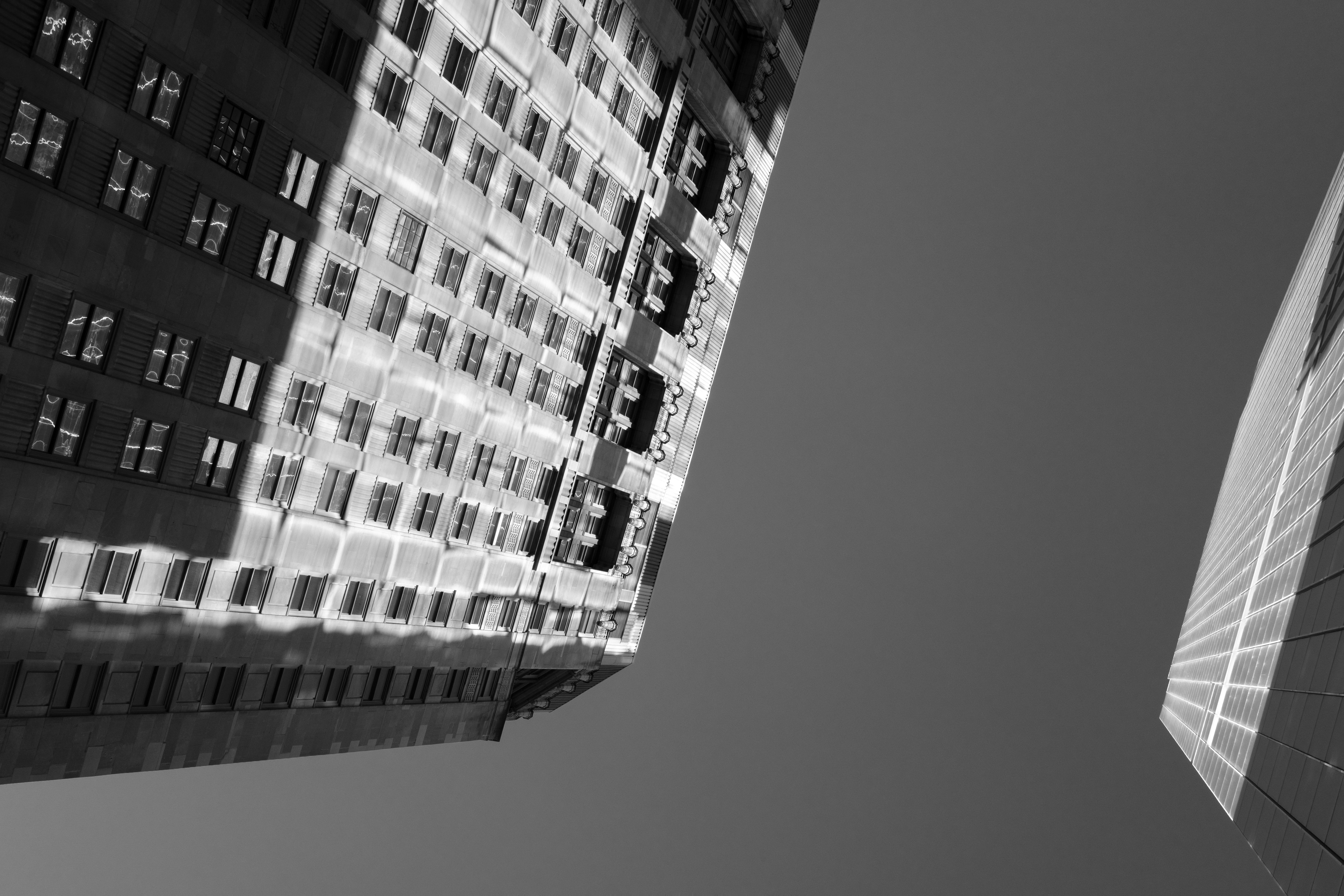 Skyward Convergence: Downtown Shadows in Monochrome
