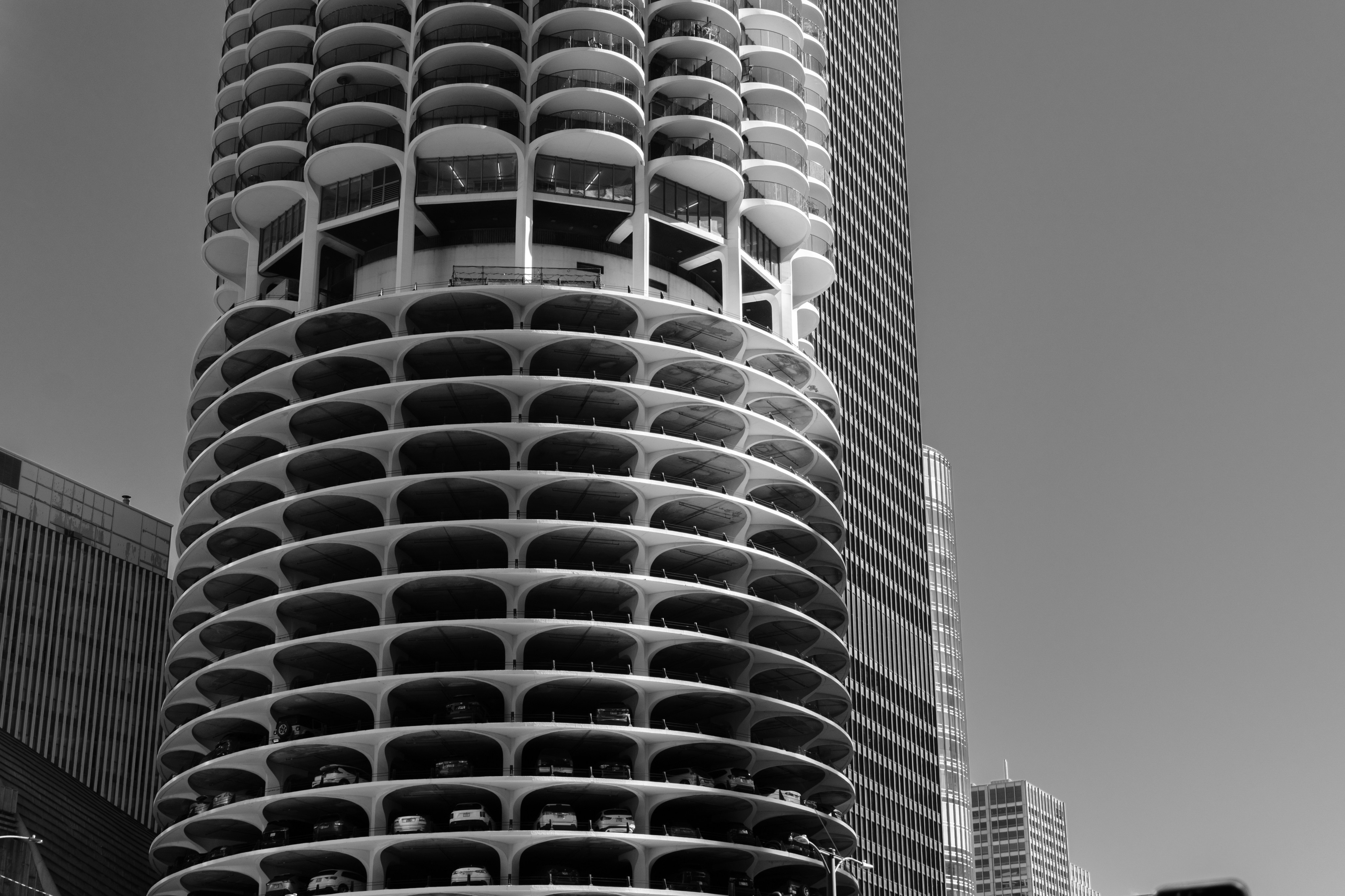 Black and white circular building with many balconies.