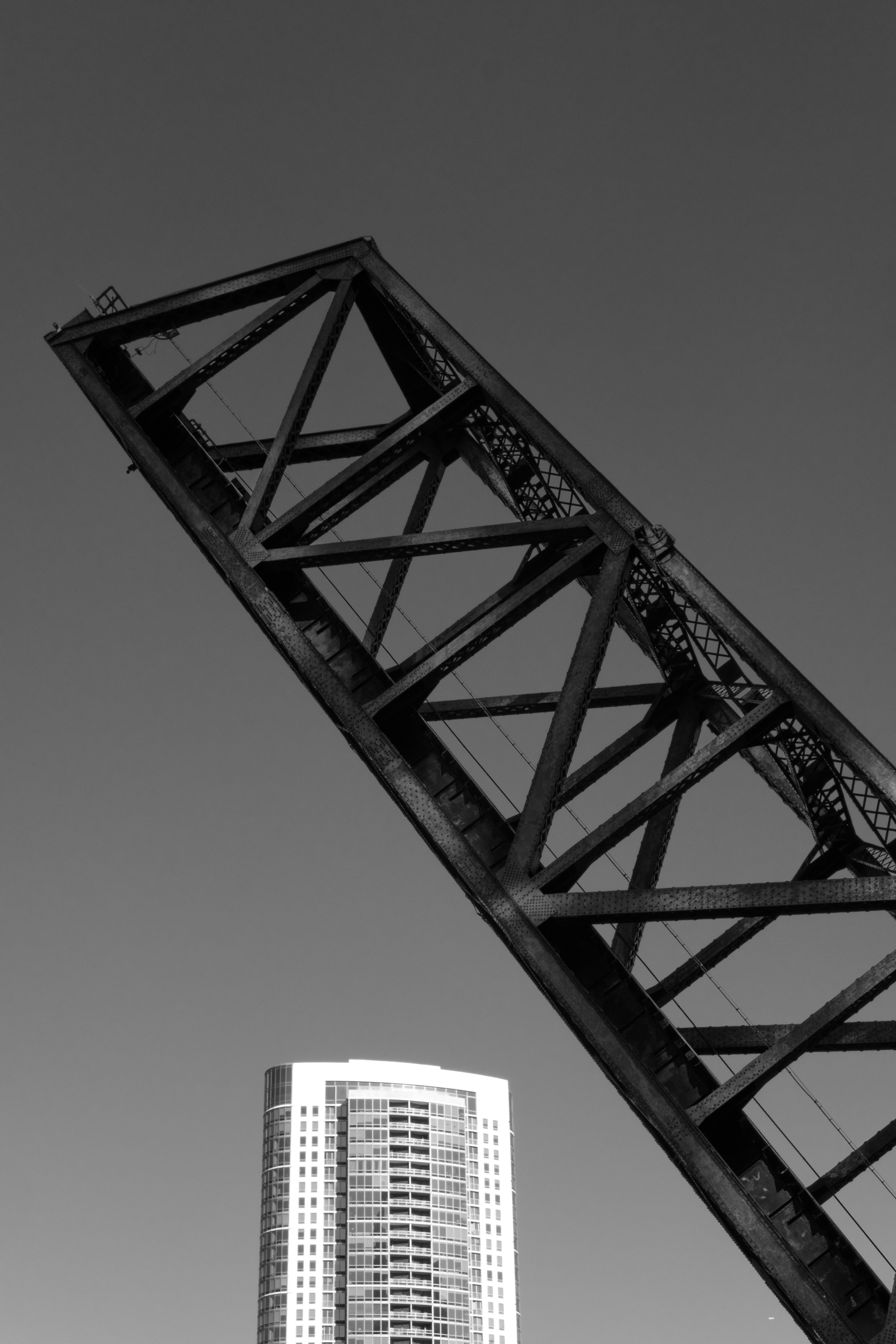 Diagonal Steel Arc: A Towering Bridge Frame Against a Quiet Skyline