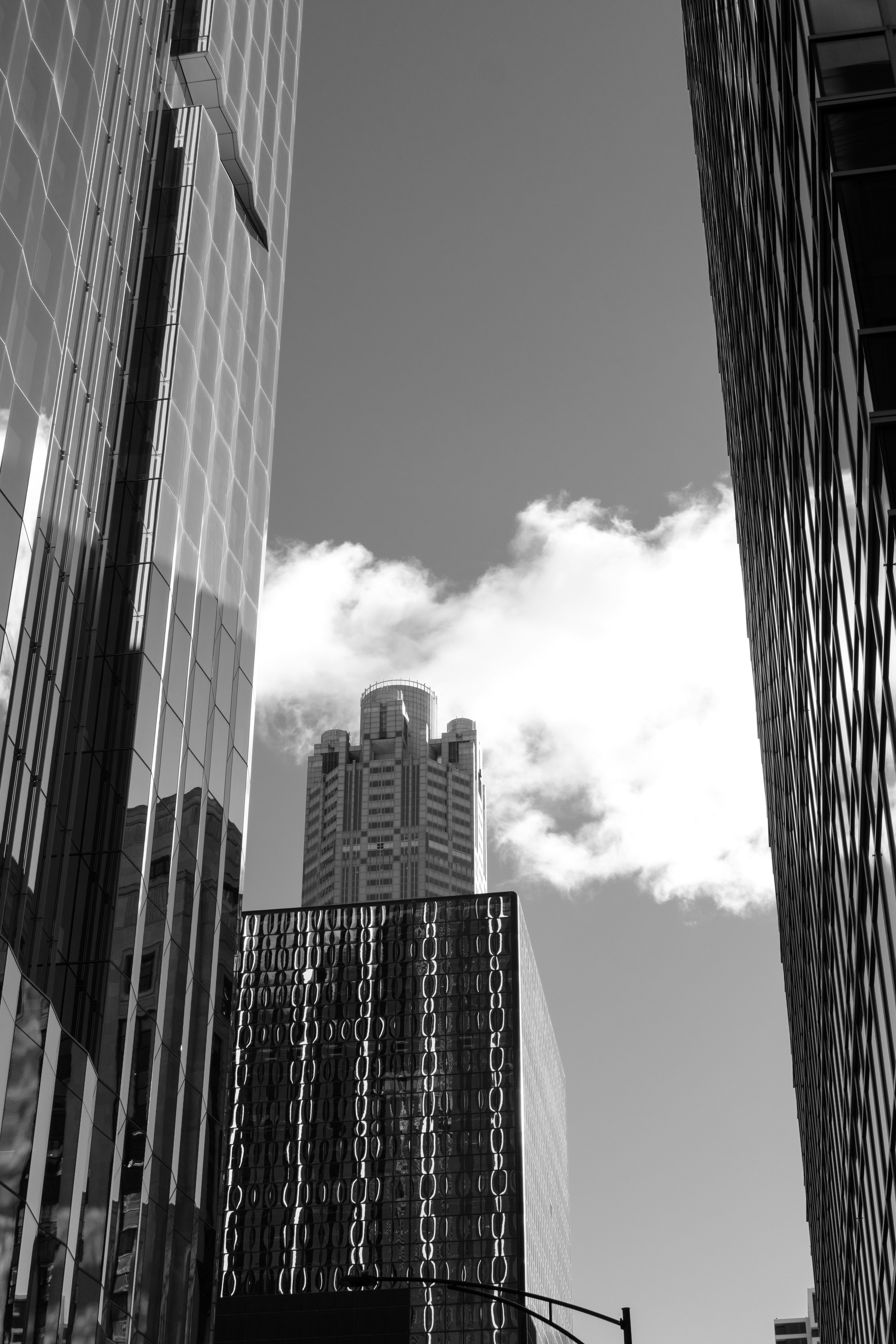 Skyward Narrow: City Towers Framing a Distant Peak
