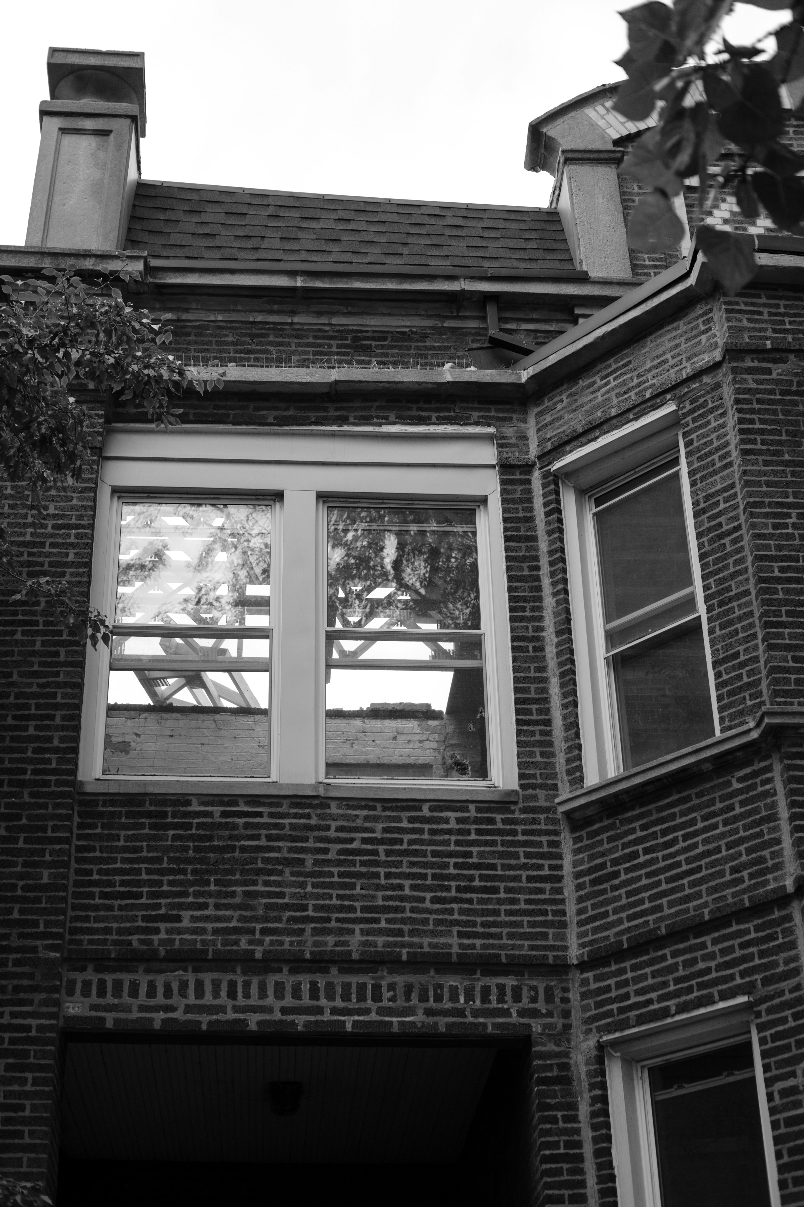 Brick Facade and Window Reflection: A Quiet Urban Portrait