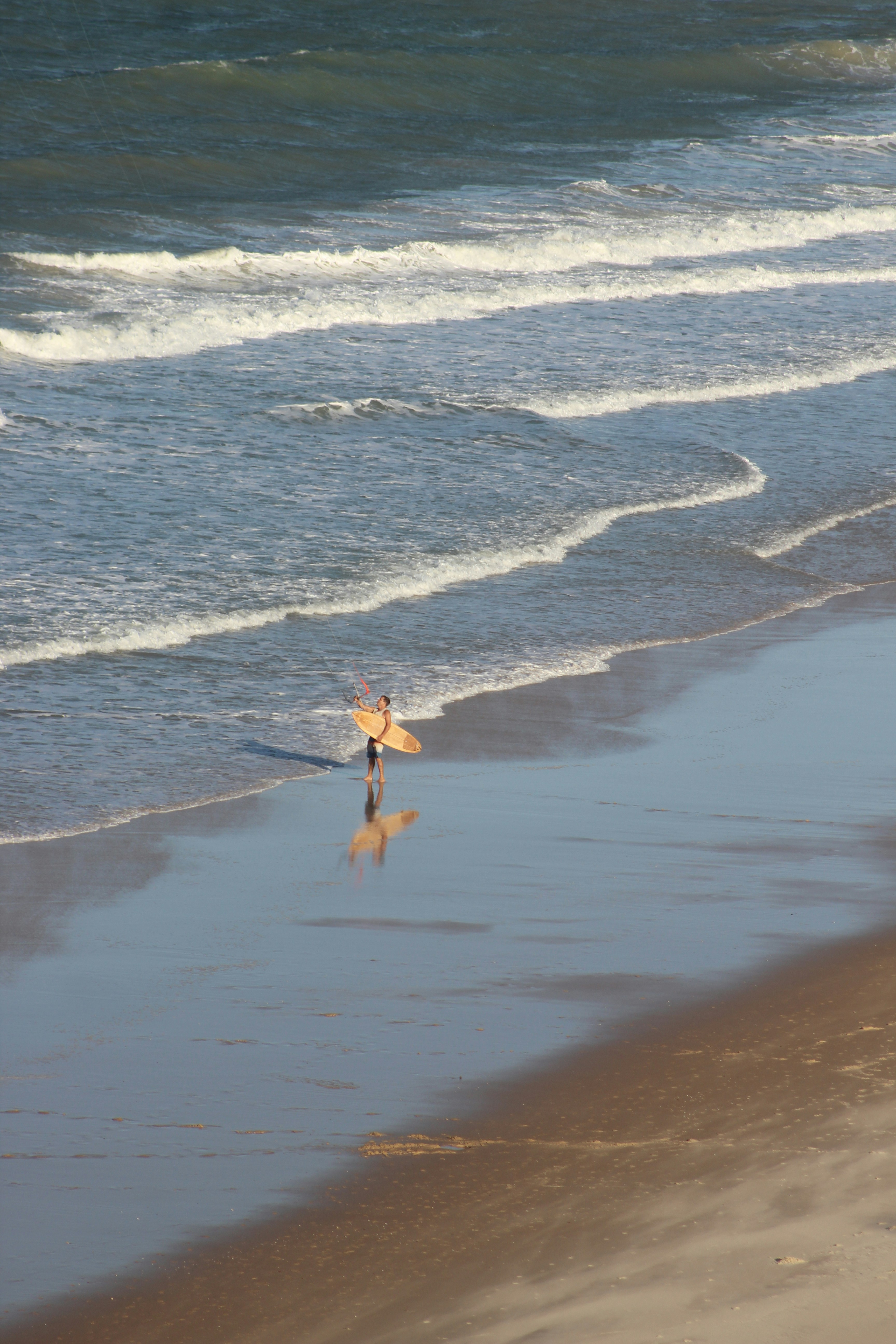 Surfboarder at the Quiet Edge: A Lone Ride along Dawn-warmed Shore