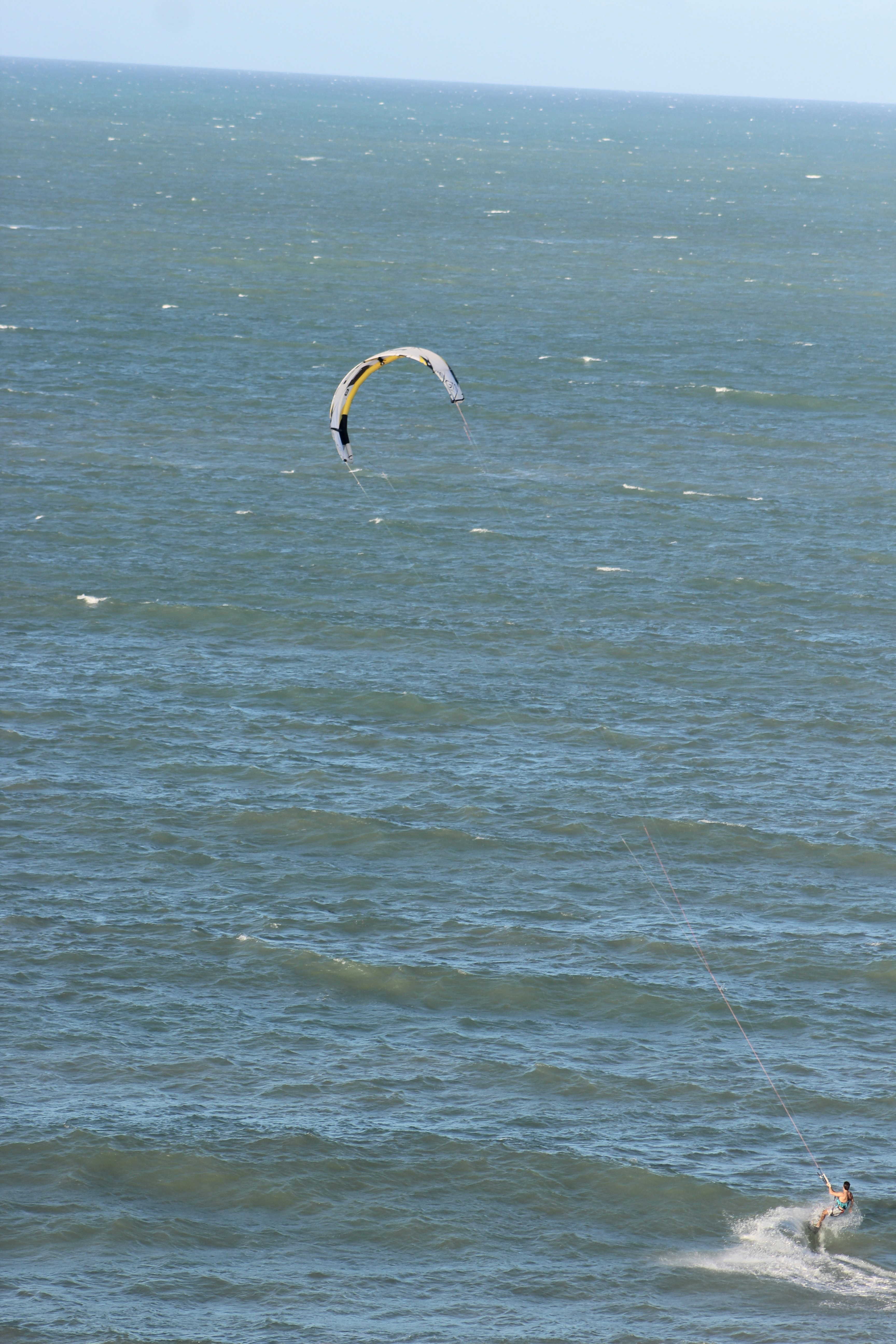 Coastal Arc: A Kite Surfer Carves the Sea