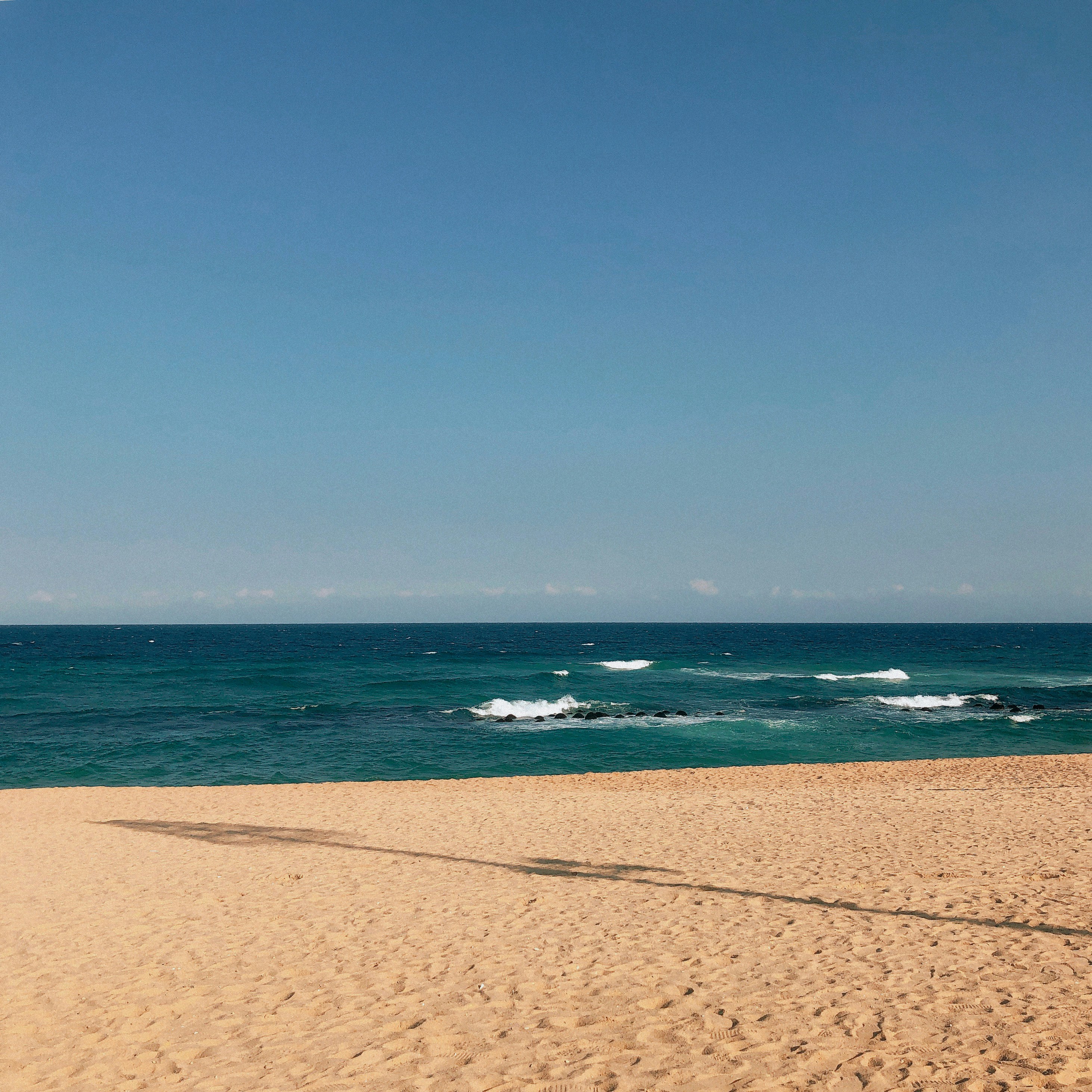 Golden Sands Meet the Sea: A Quiet Horizon at Noon