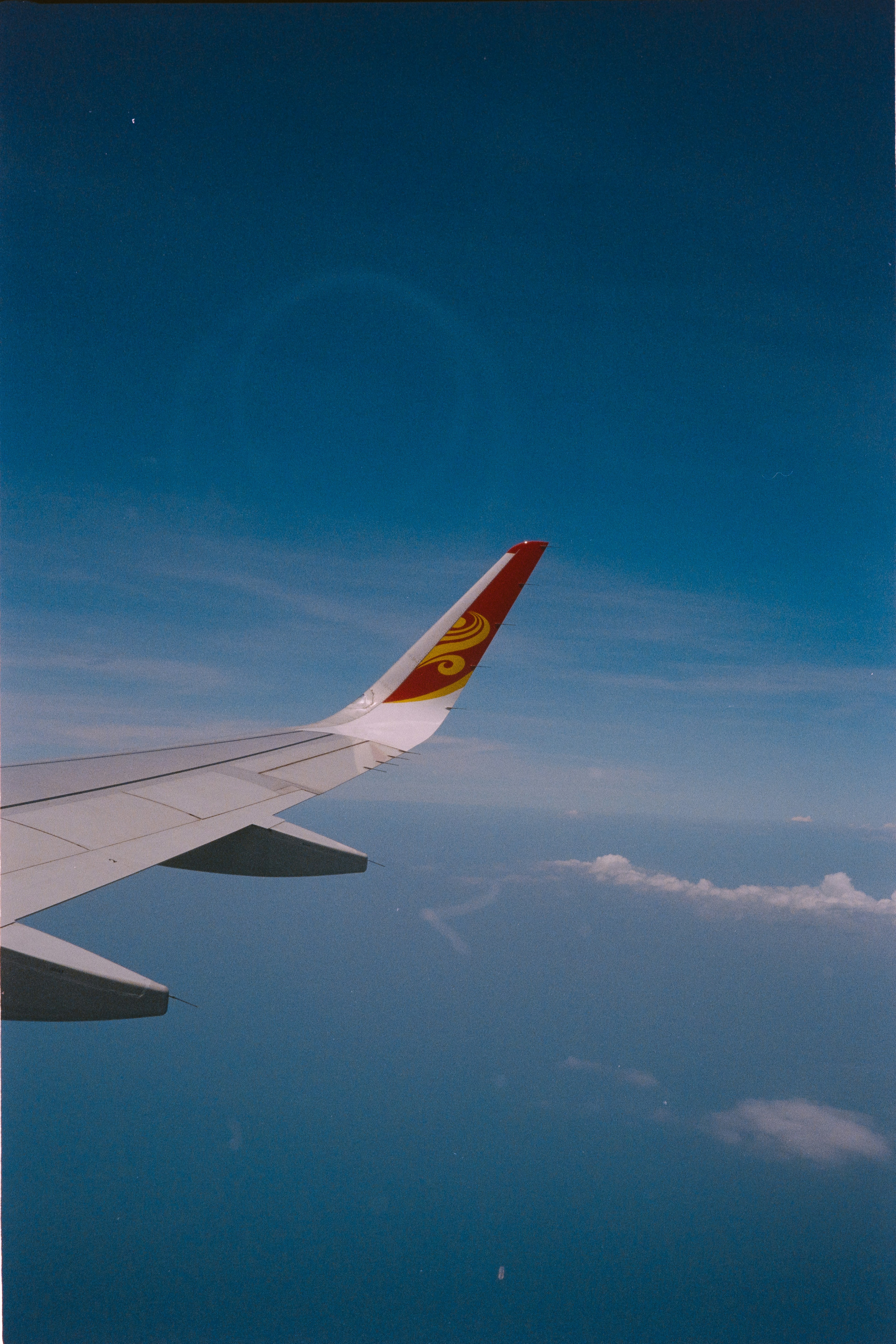 Wingtip in the Sky: Aerial View from a Sunlit Cabin Window