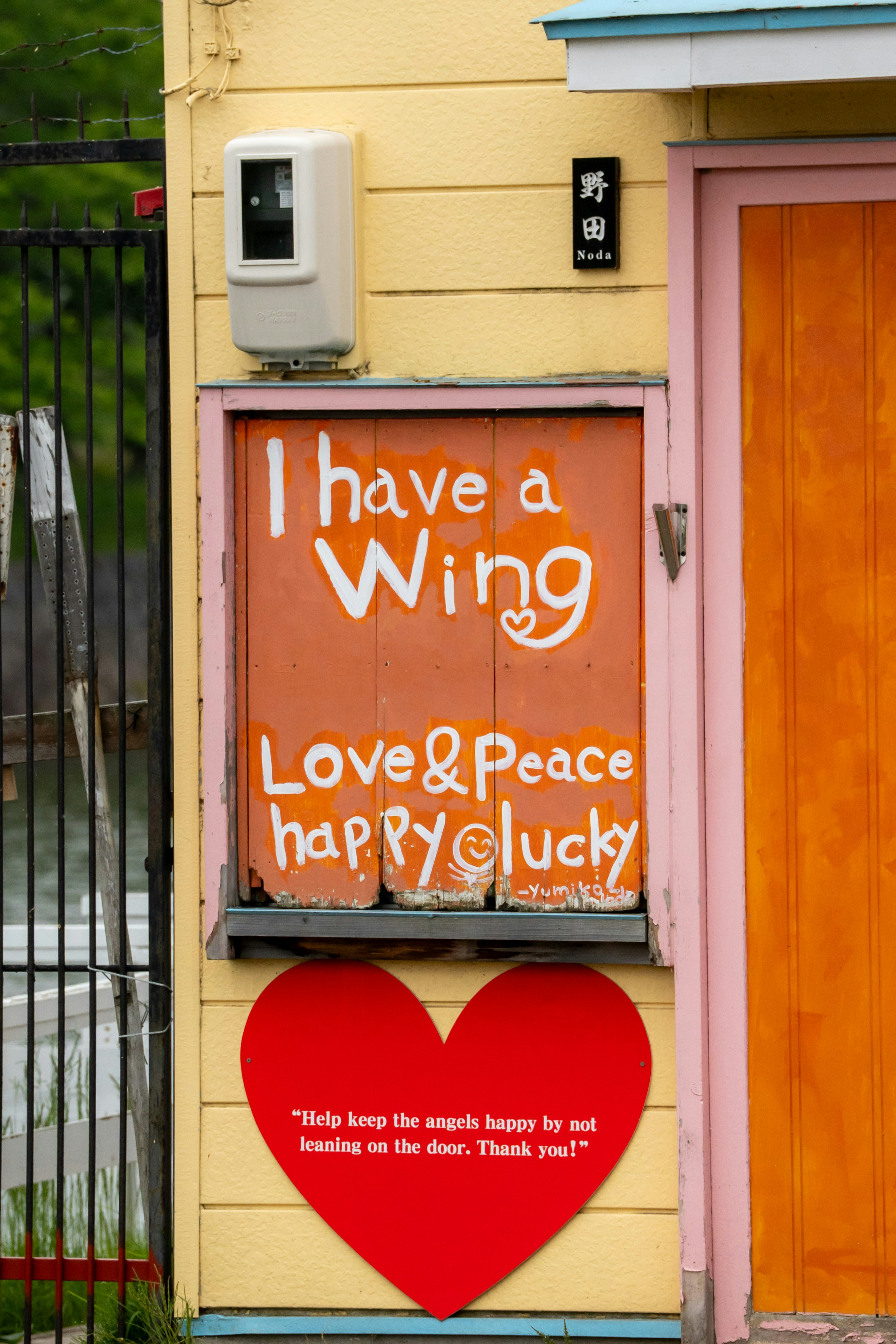 Winged Hope on a Sunny Orange Door