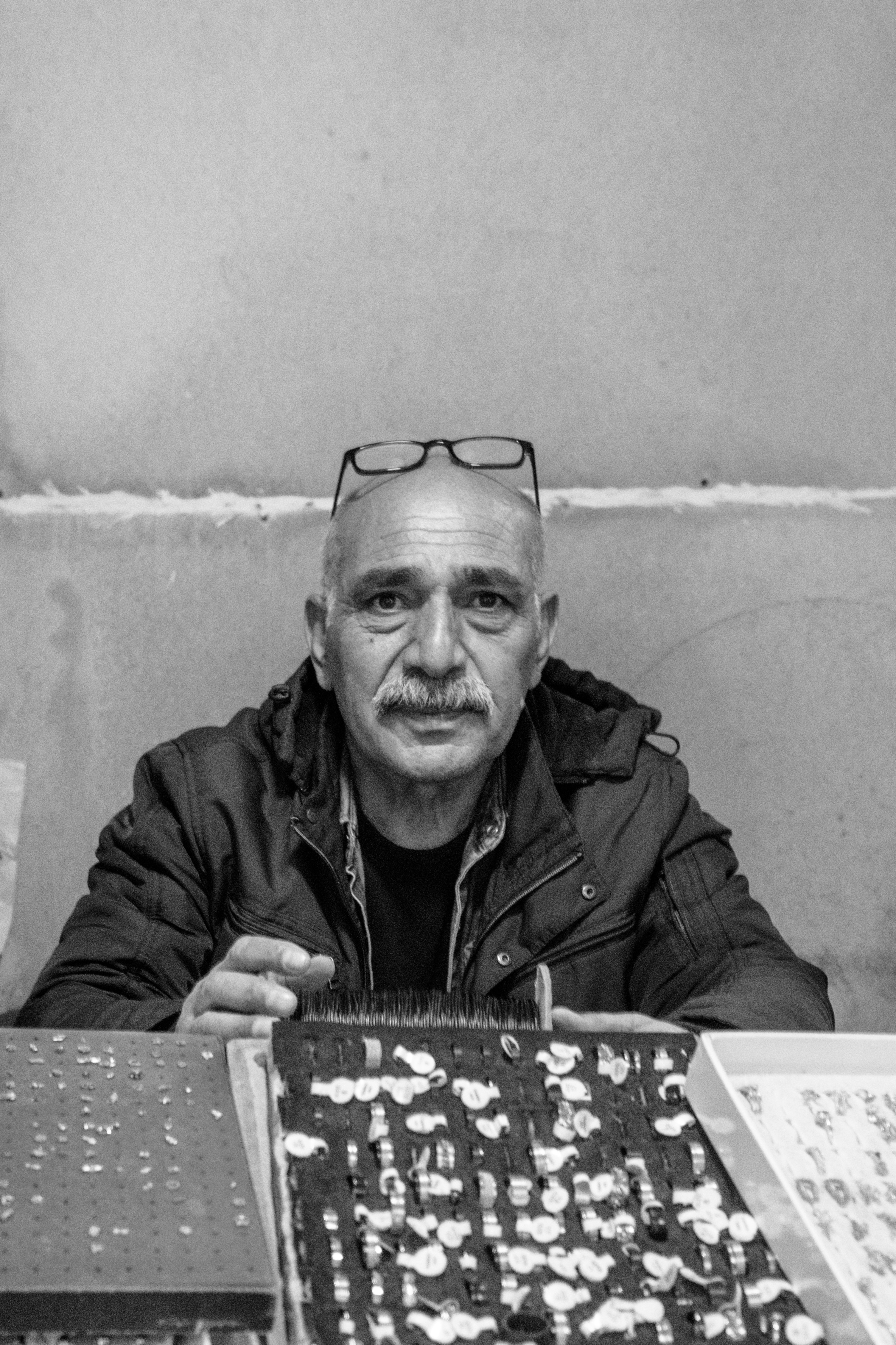 Gregory at the Jewelry Bench: Quiet Focus at a Market Stall
