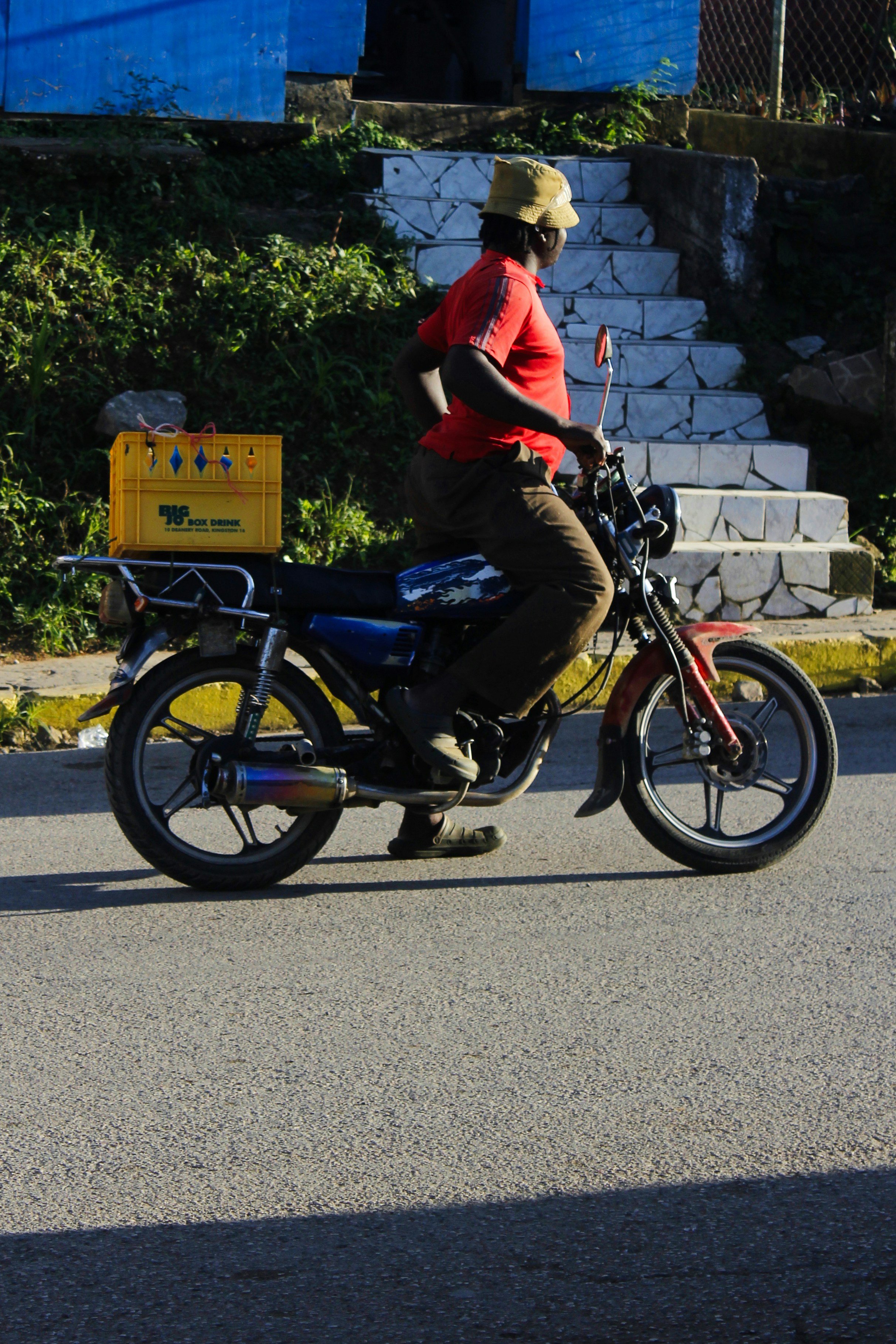Rider in Red: A Quiet Ride Past Steps and Sturdy Mossy Greenery