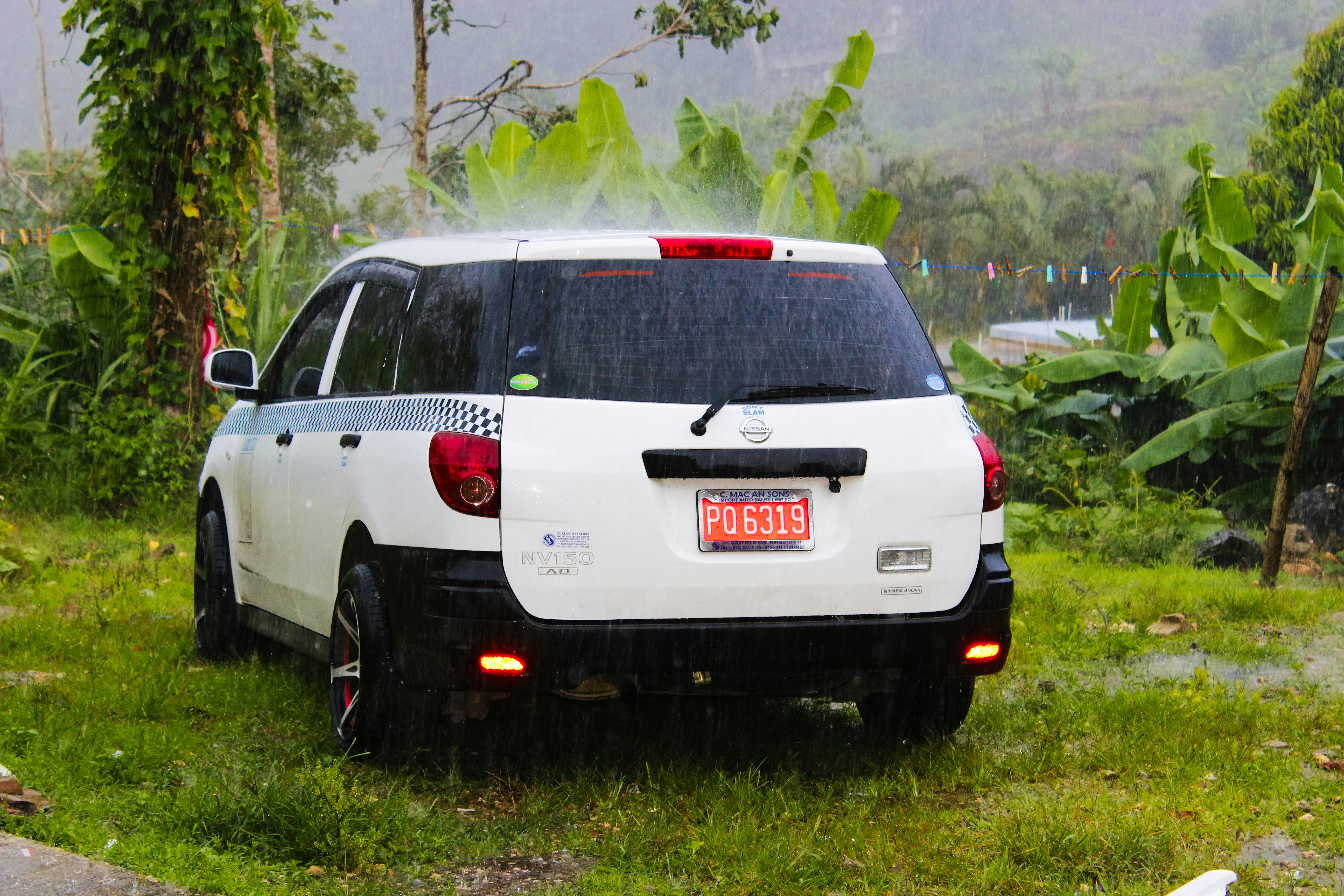White SUV at Rainy Rural Stopover