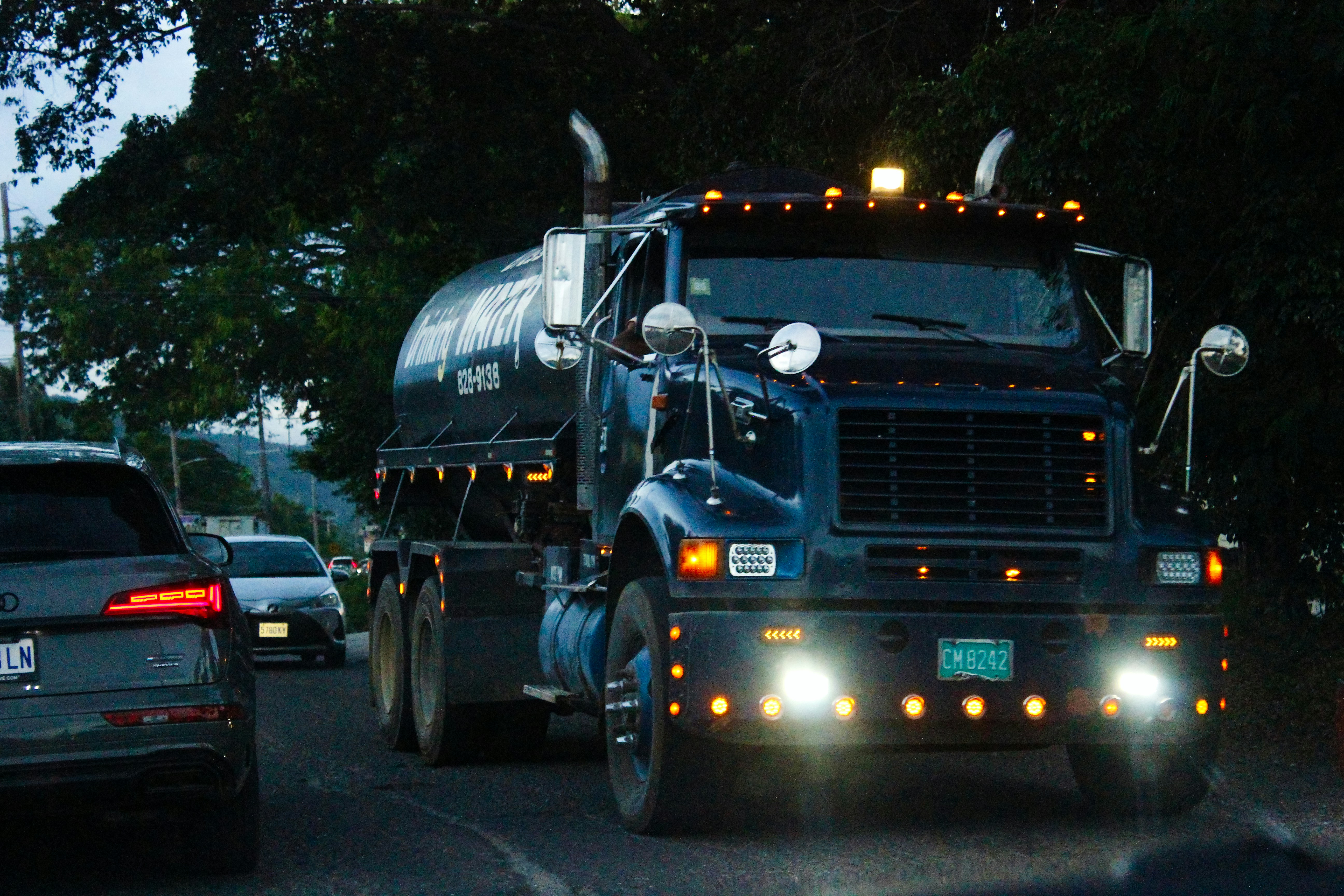 Night Roadliner: headlights bloom on a heavy-haul convoy