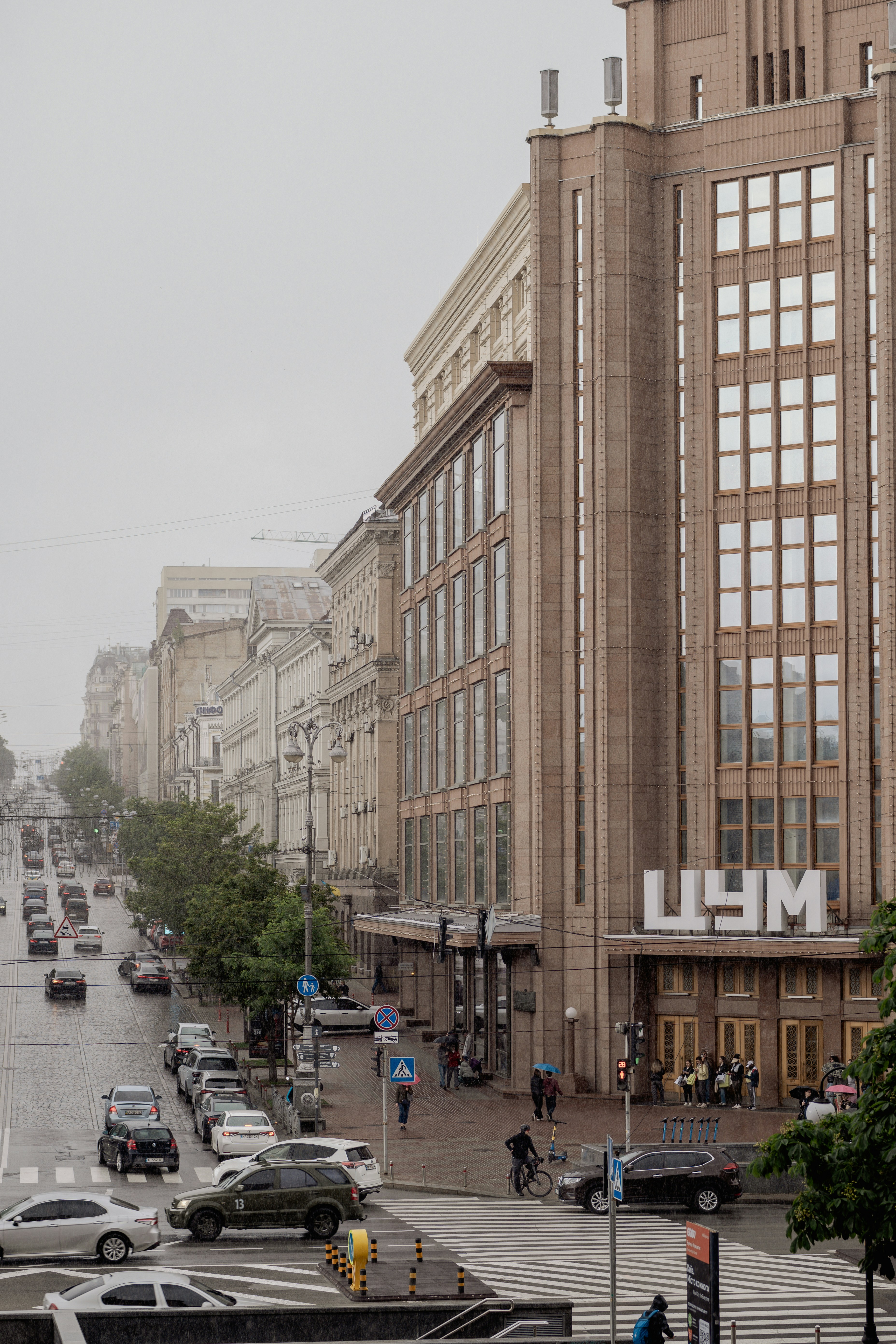 Urban Theatre: A Rainy Walk Past a Grand Brick Facade