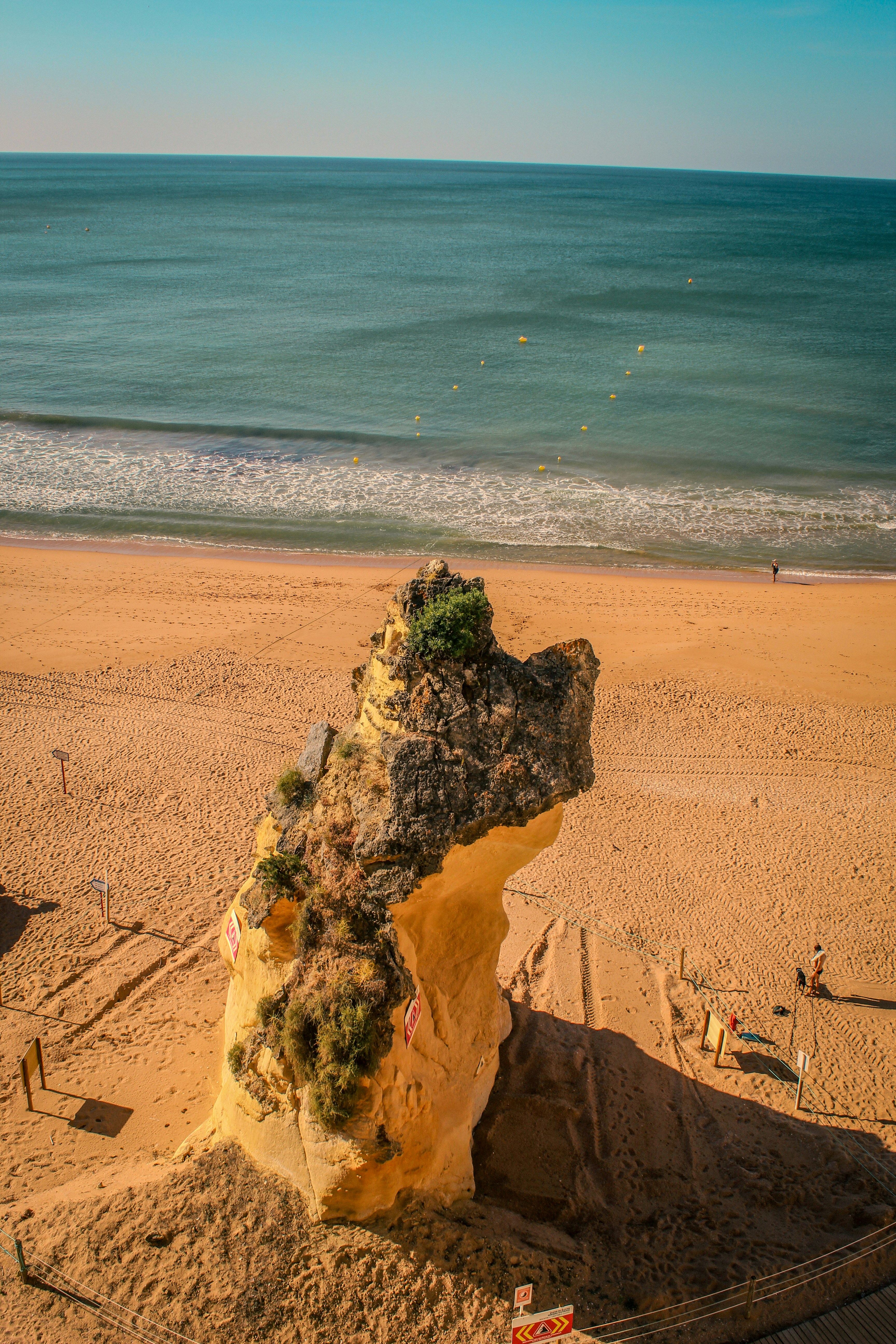 Sea Stack on a Sunlit Beach Reaching Toward the Horizon