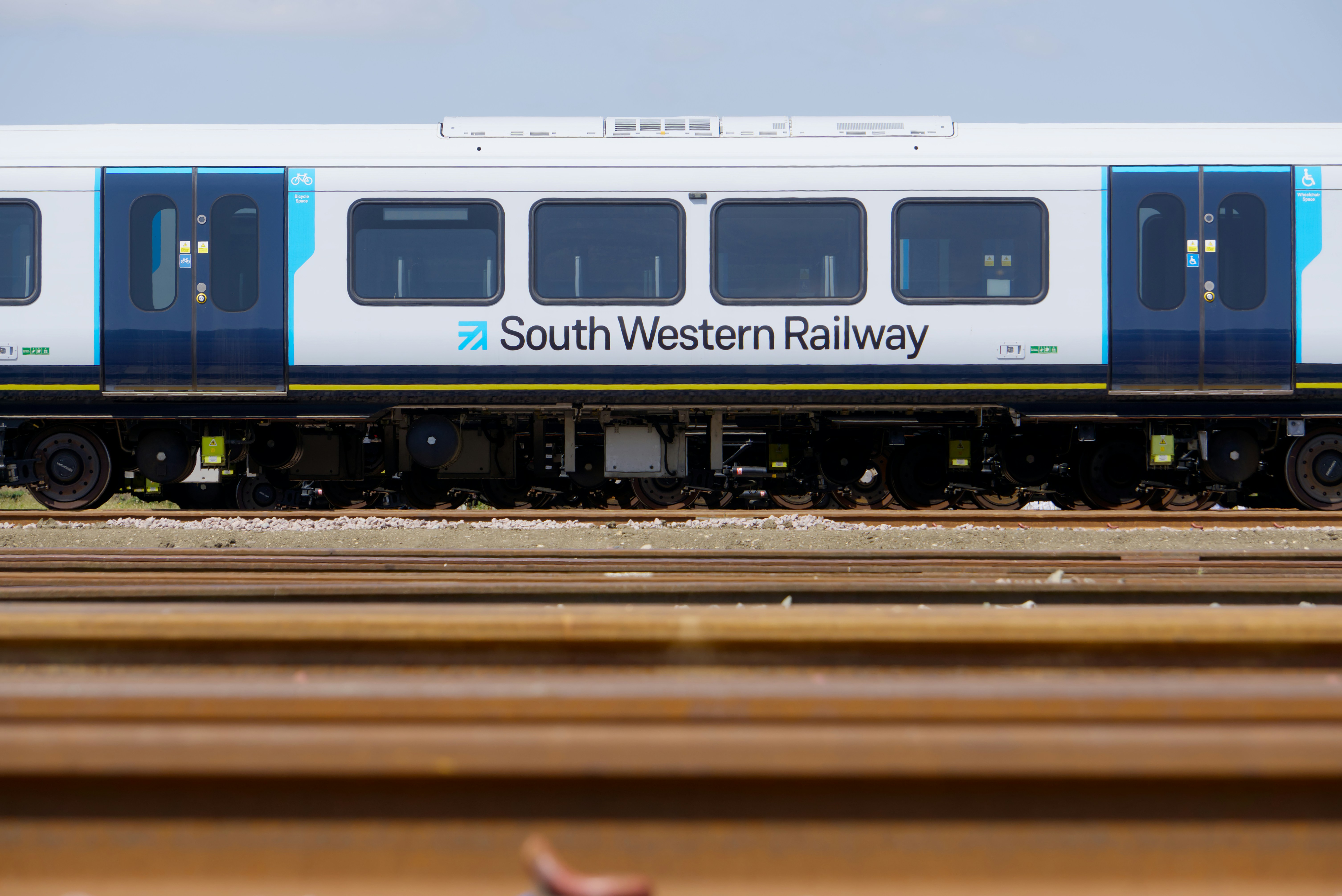 South Western Railway carriage in sunlight, rails in the foreground