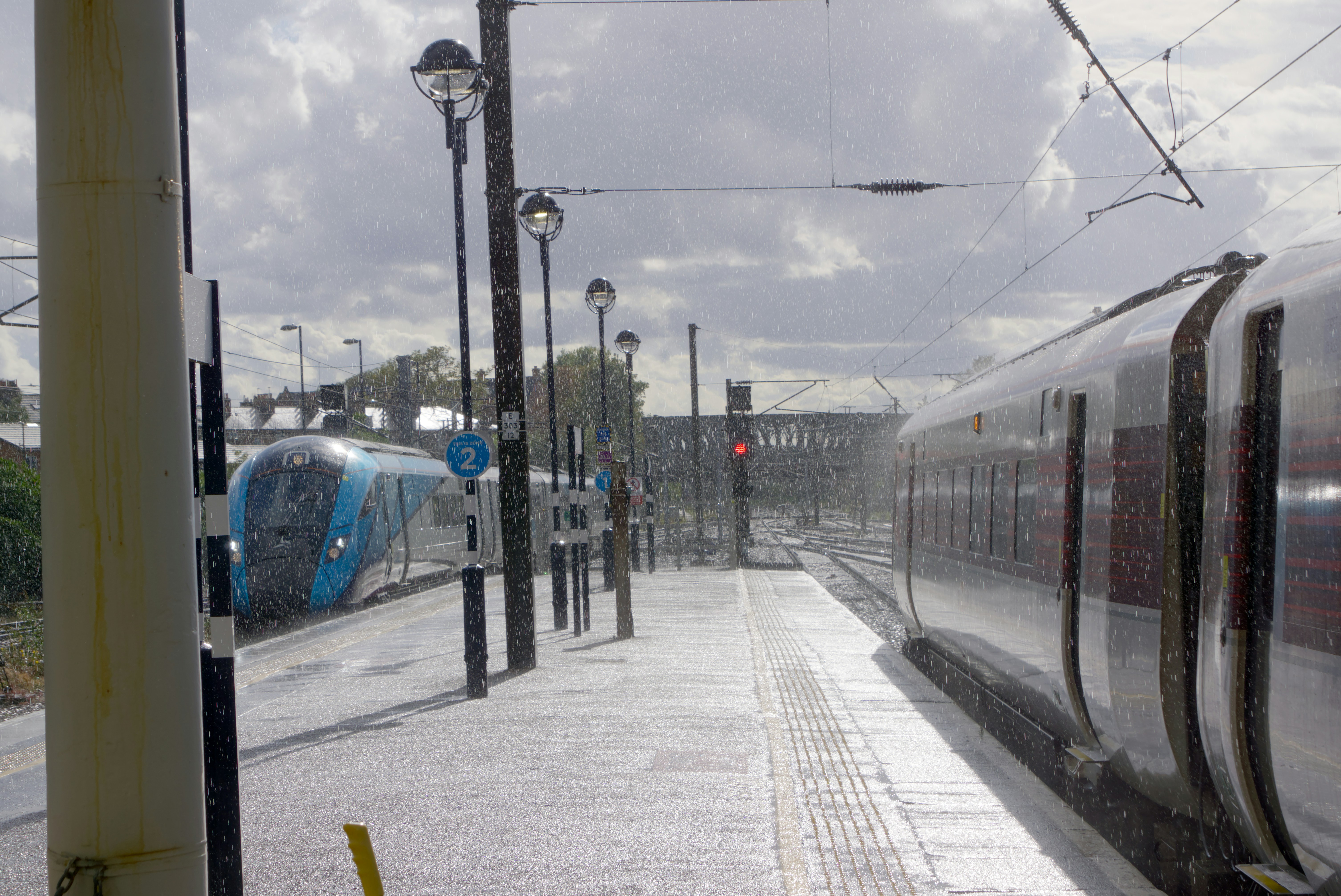 Morning Platforms: Trains Framed by Rain-Speckled Glass