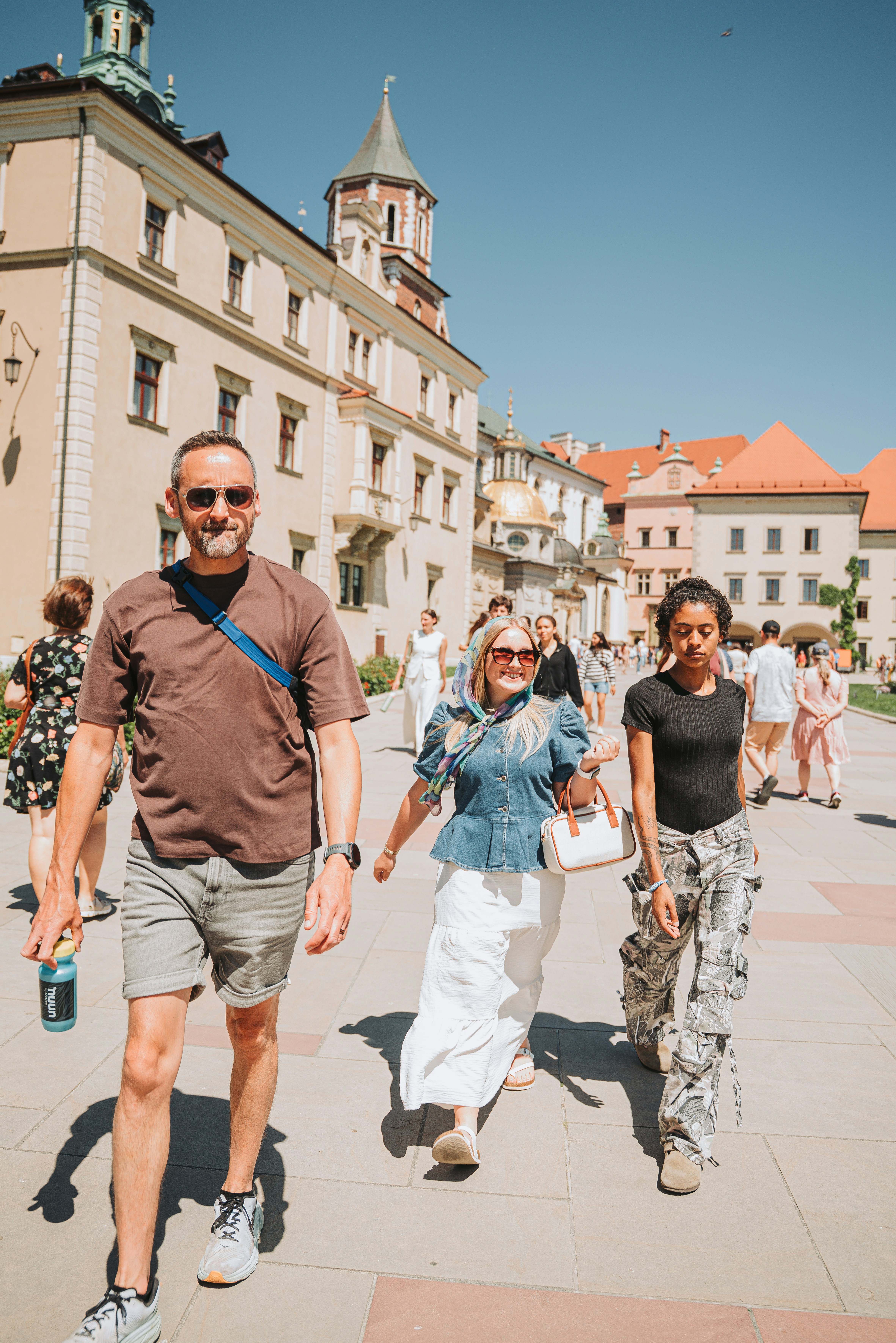Sunlit City Stroll: A Trio in the Historic Square