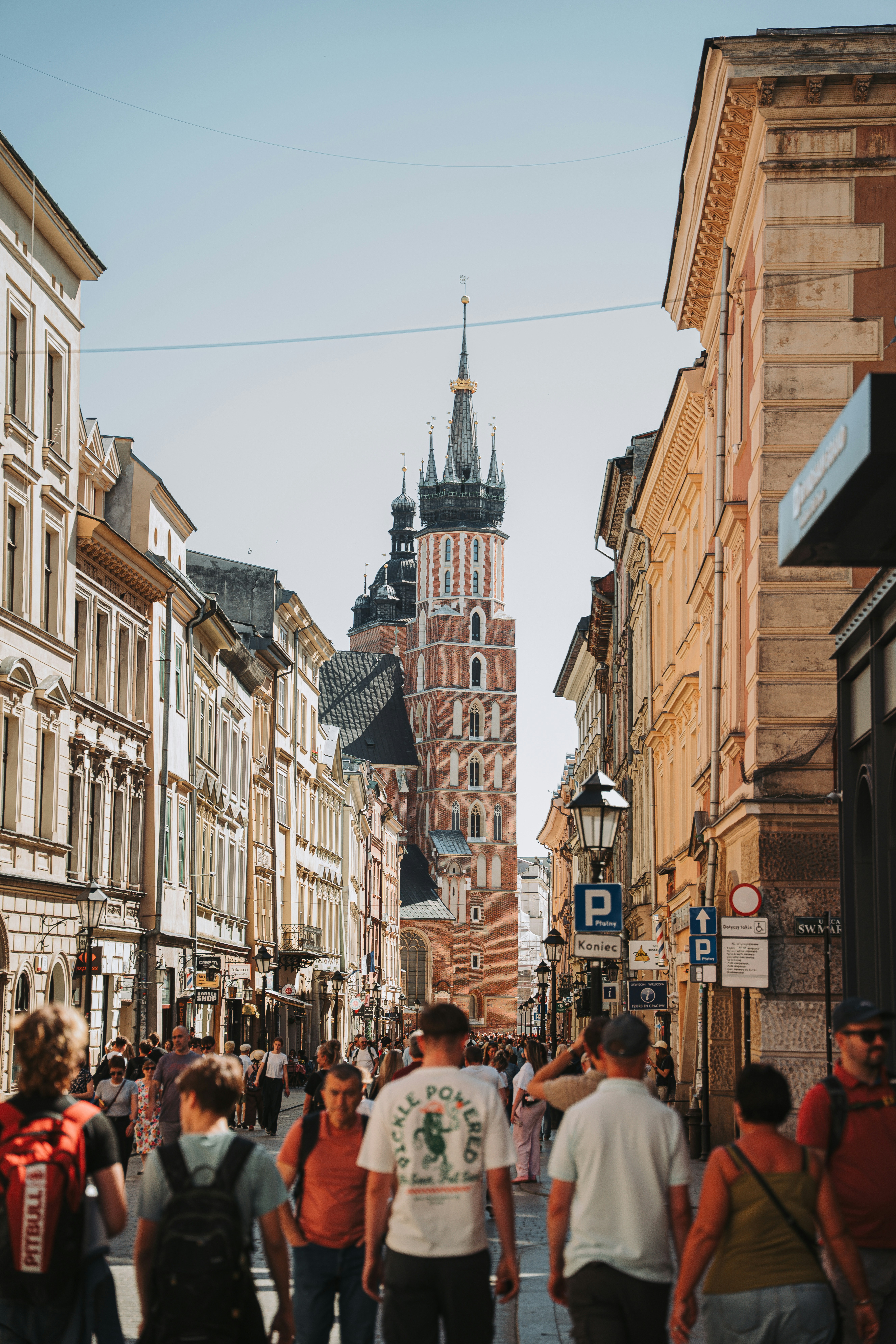 Towering Spire Amid Busy Old Town Street
