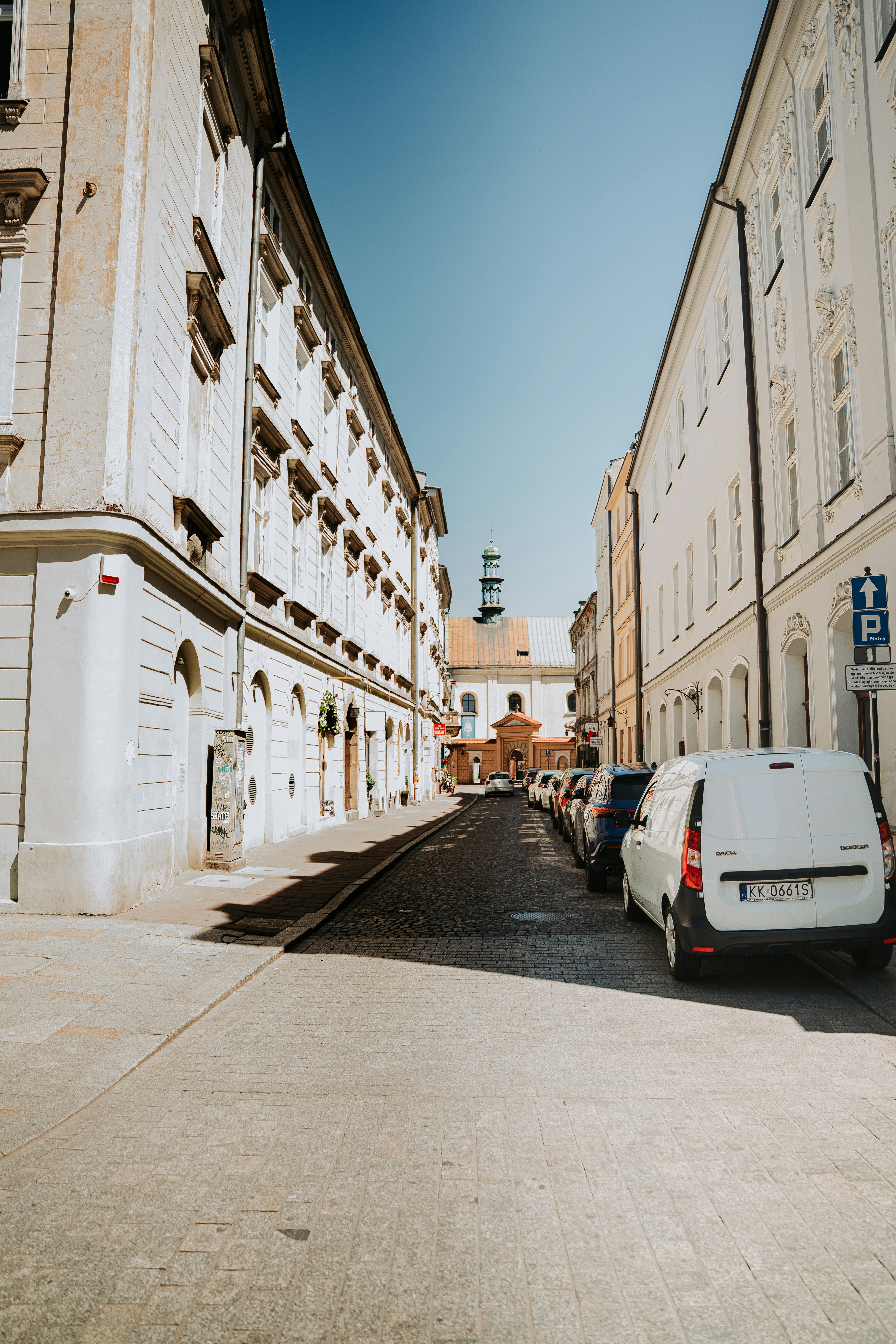 Cobbled Street Toward a Clock Tower