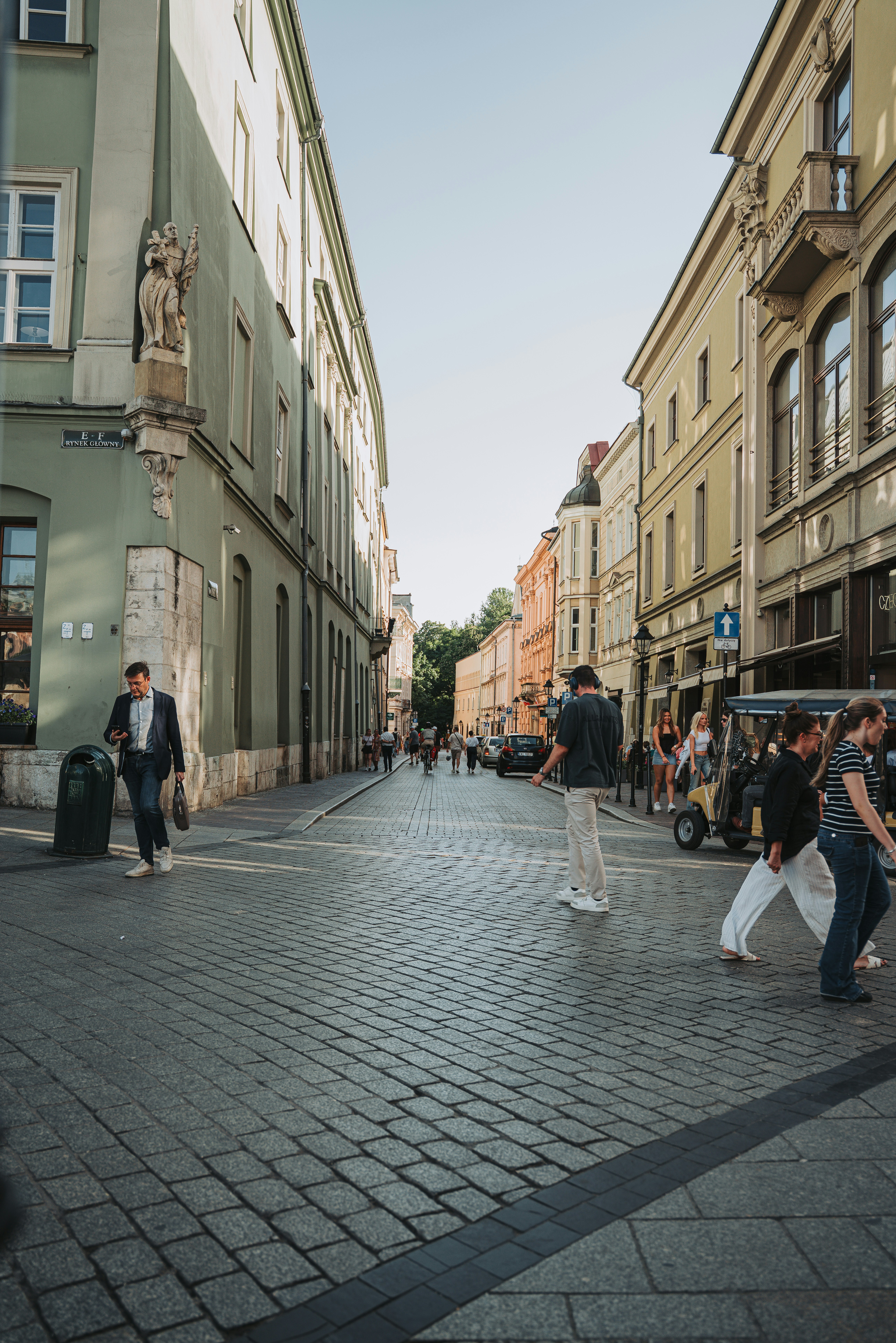 City Street in Golden Hour: Pedestrians and Historic Facades