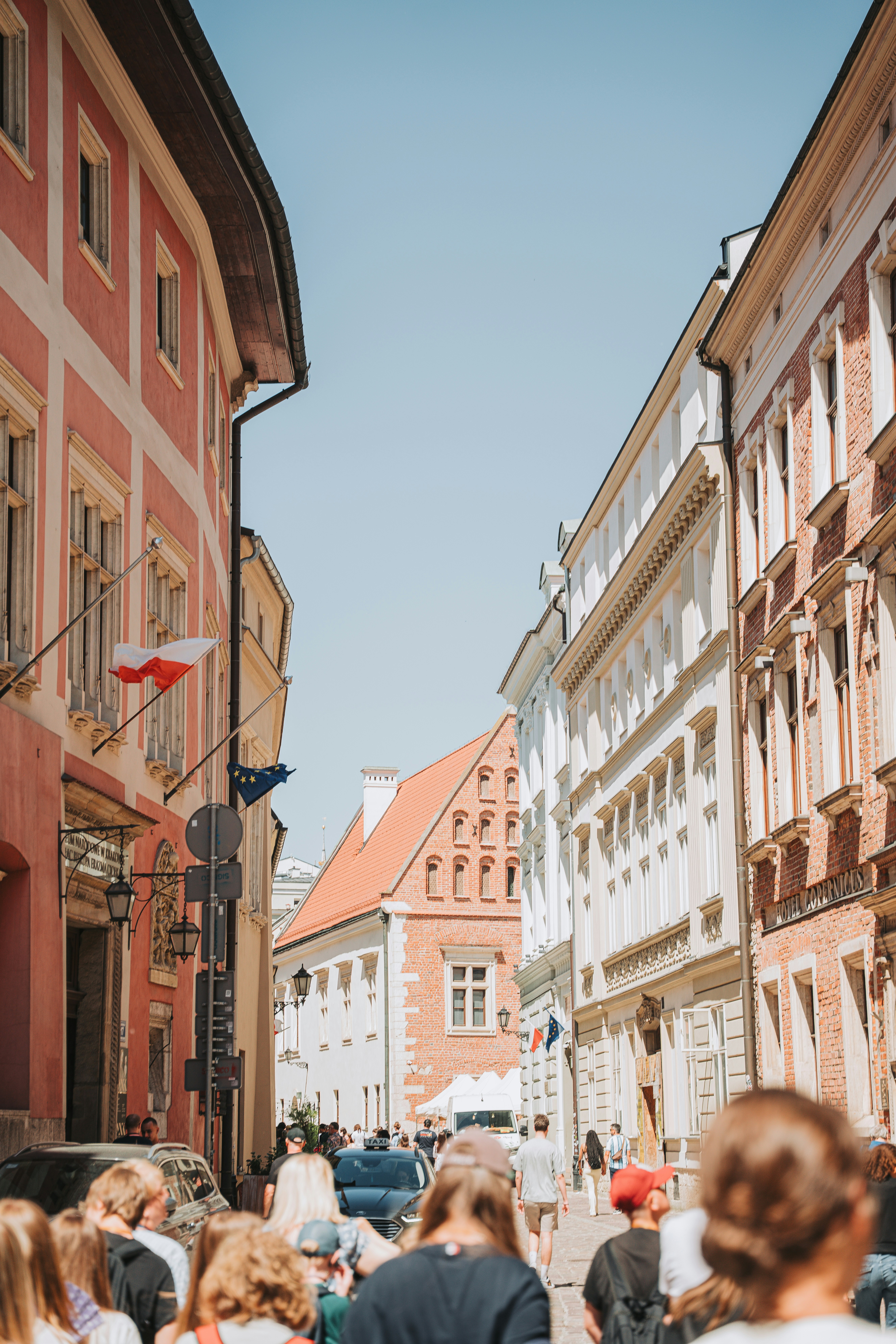 Sunlit City Lane: A Historic Street Packed with People