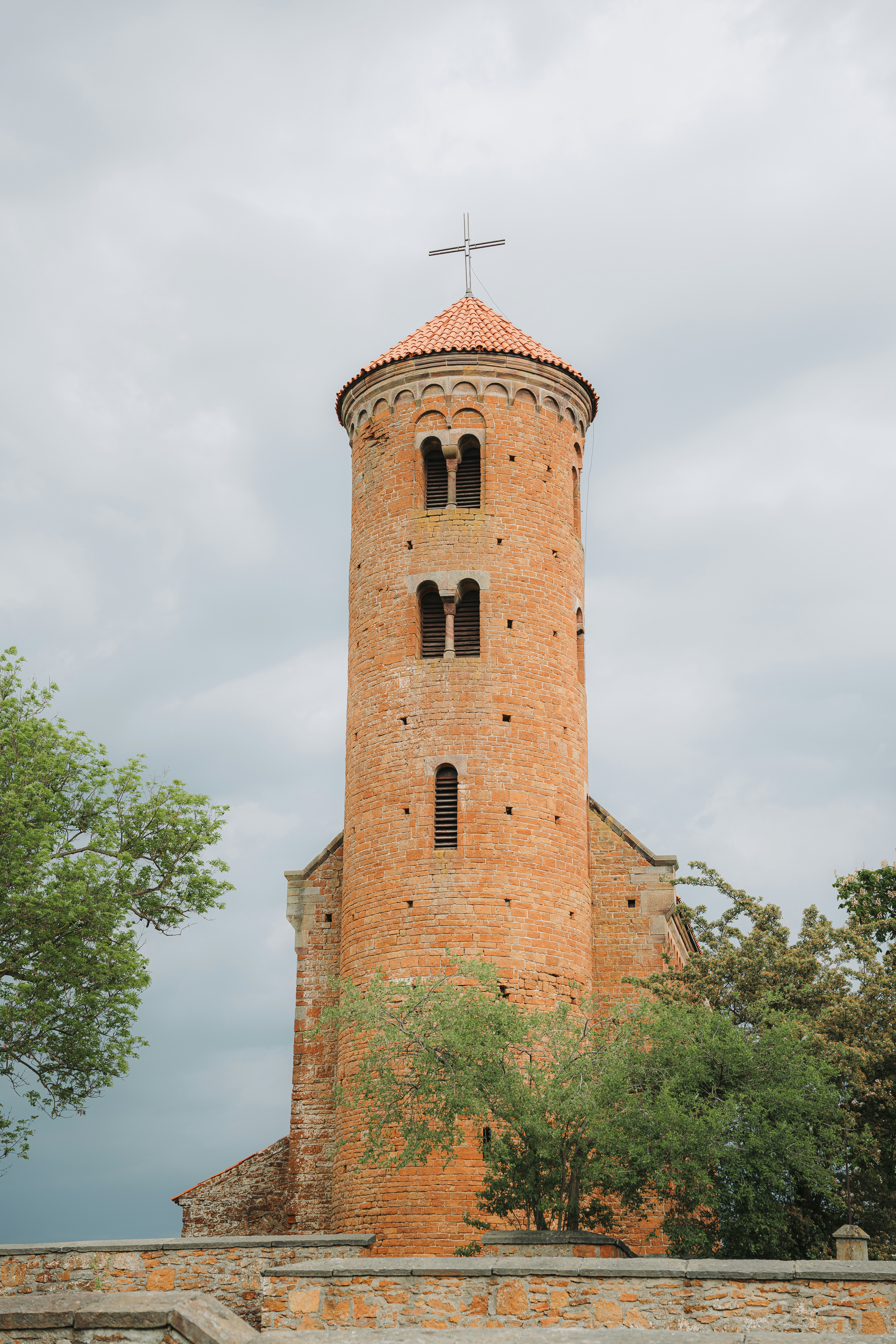 Tower of Brick Echoes: A Lone Bell-Tower Rises Against Clouds