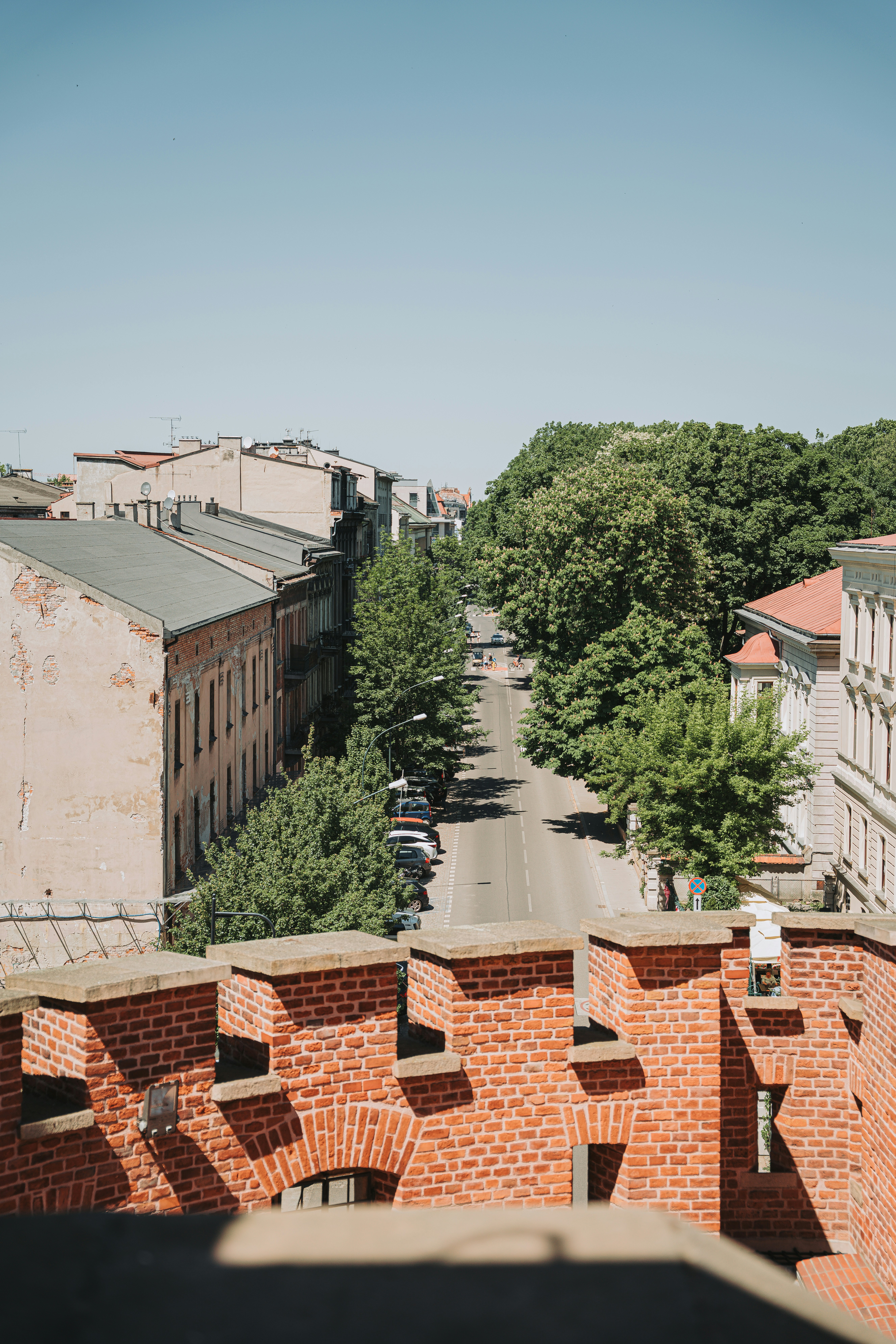 Brick Ramparts Over the Street: A Quiet City View from the Terrace