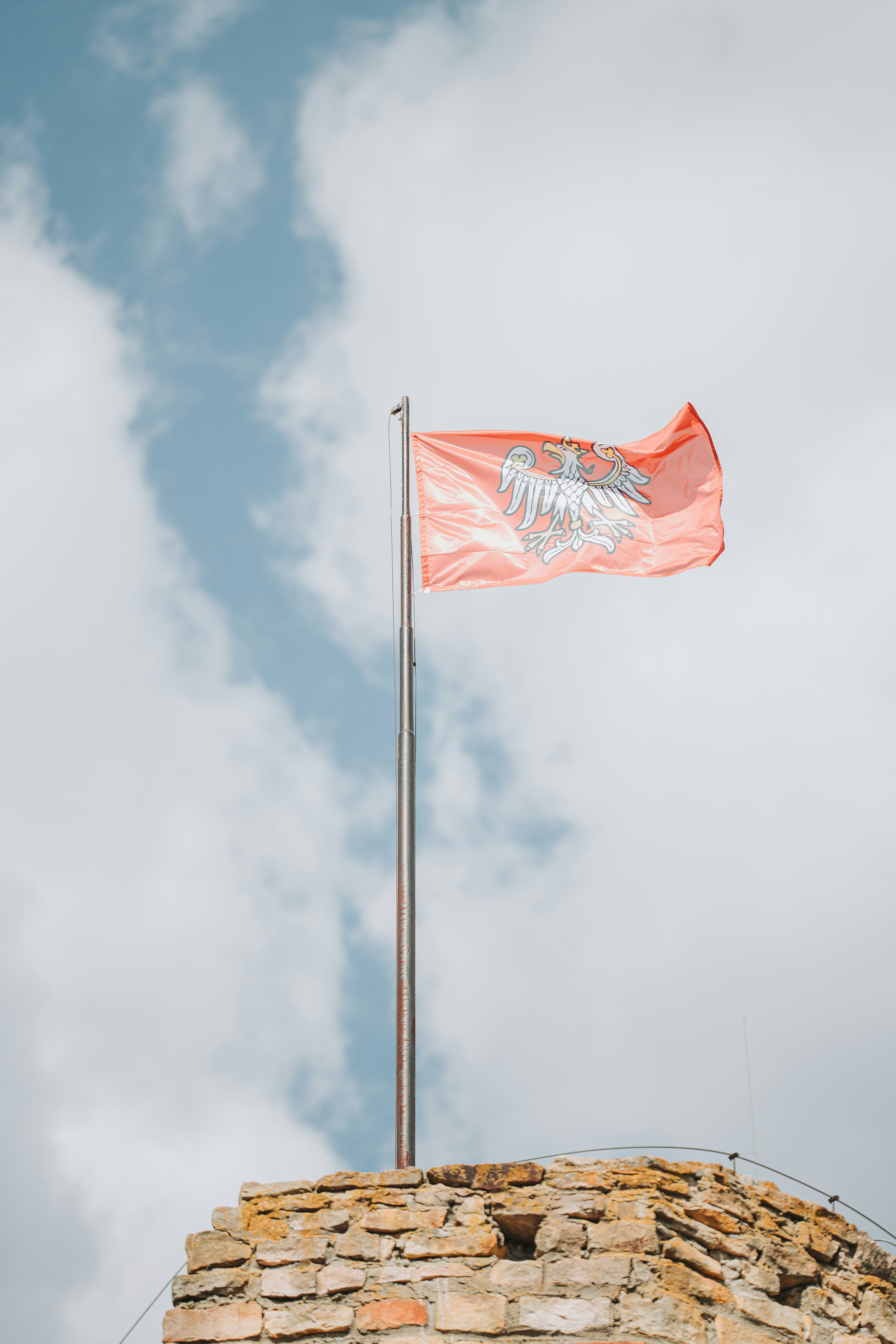 Flag on a Weathered Stone Plinth Under Expansive Sky