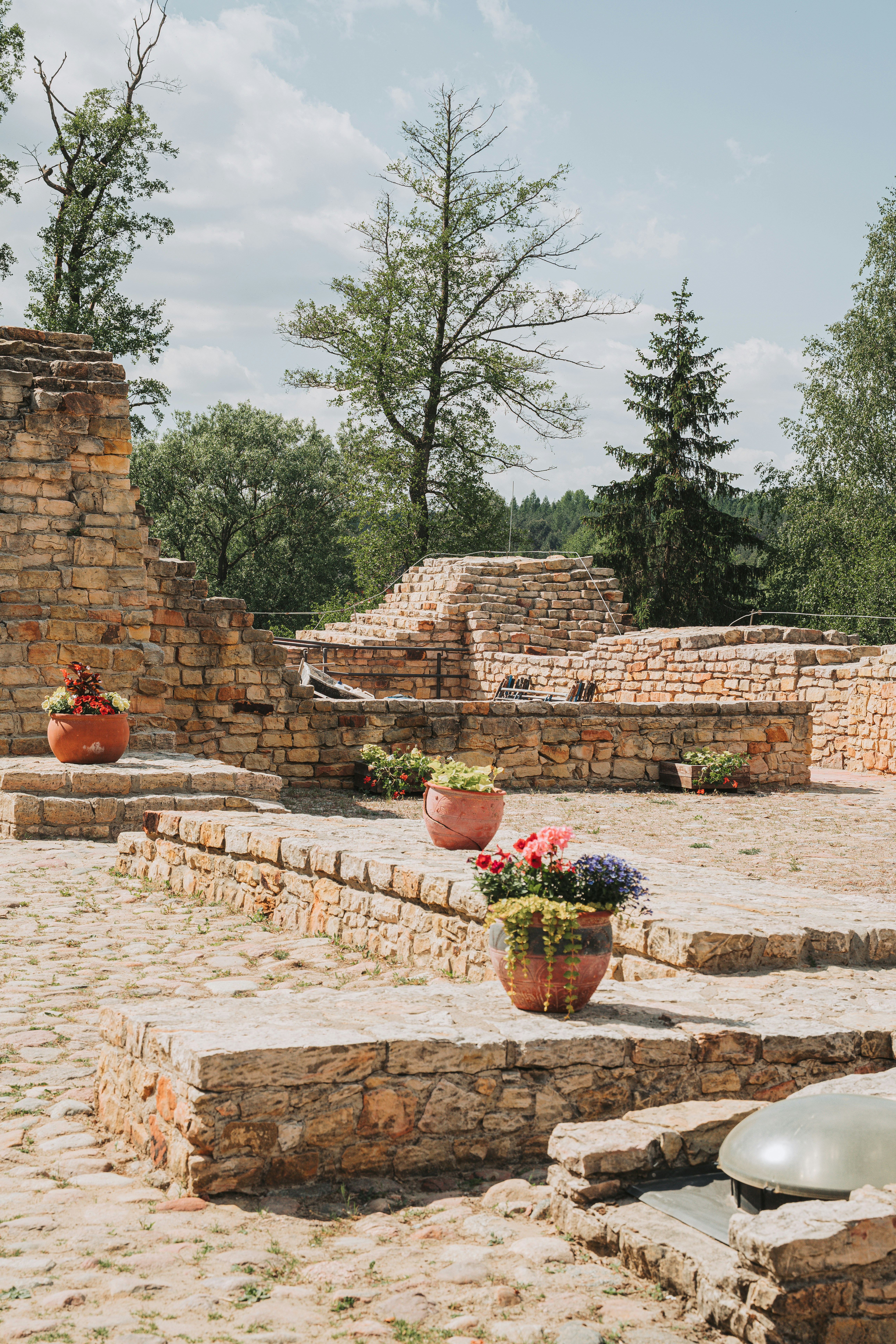 Sunlit Terrace of Ancient Brickwork with Flower Pots